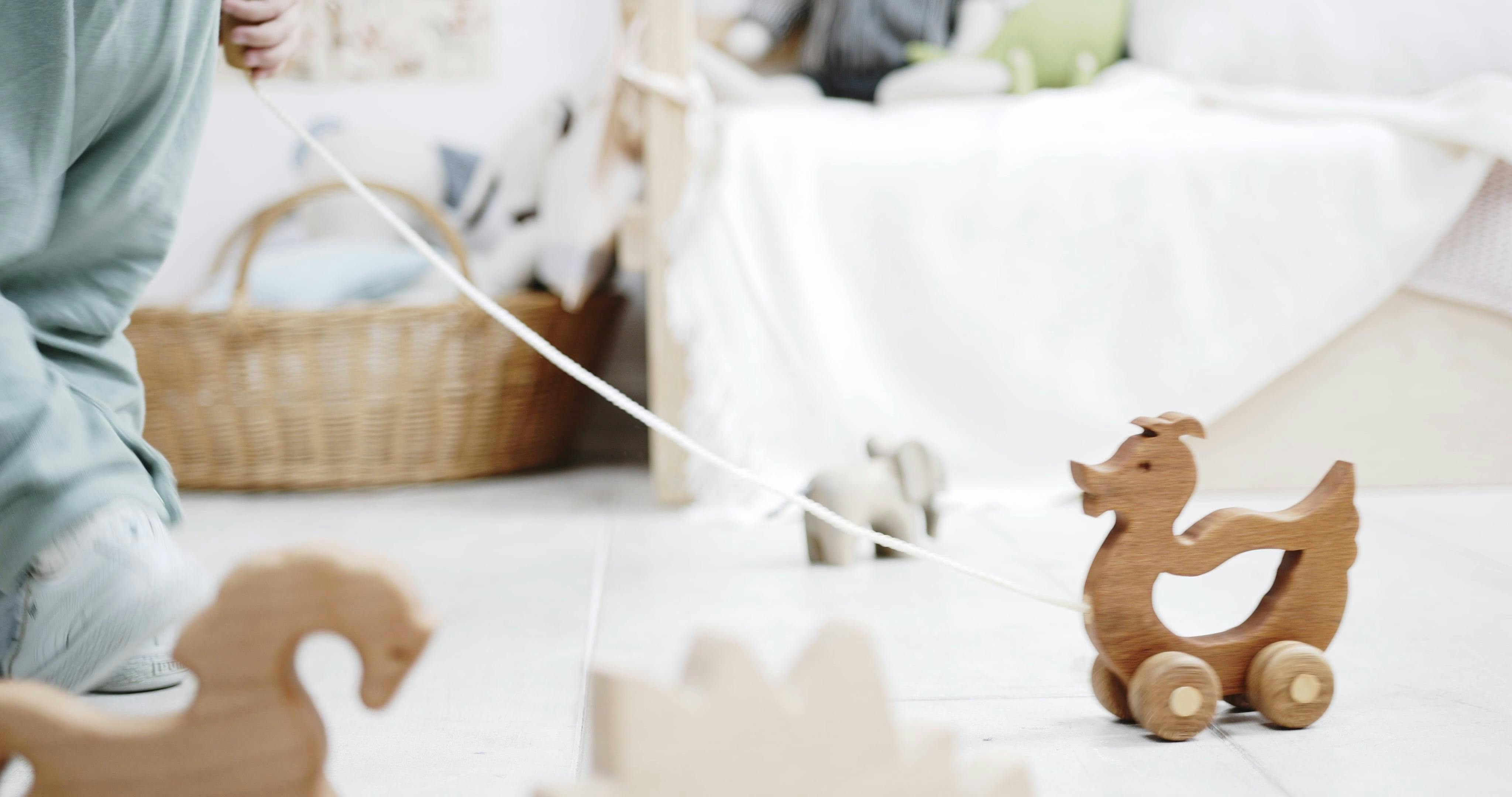 A Kid Pulling A Wooden Toy With Wheels By The String Free Stock Video ...