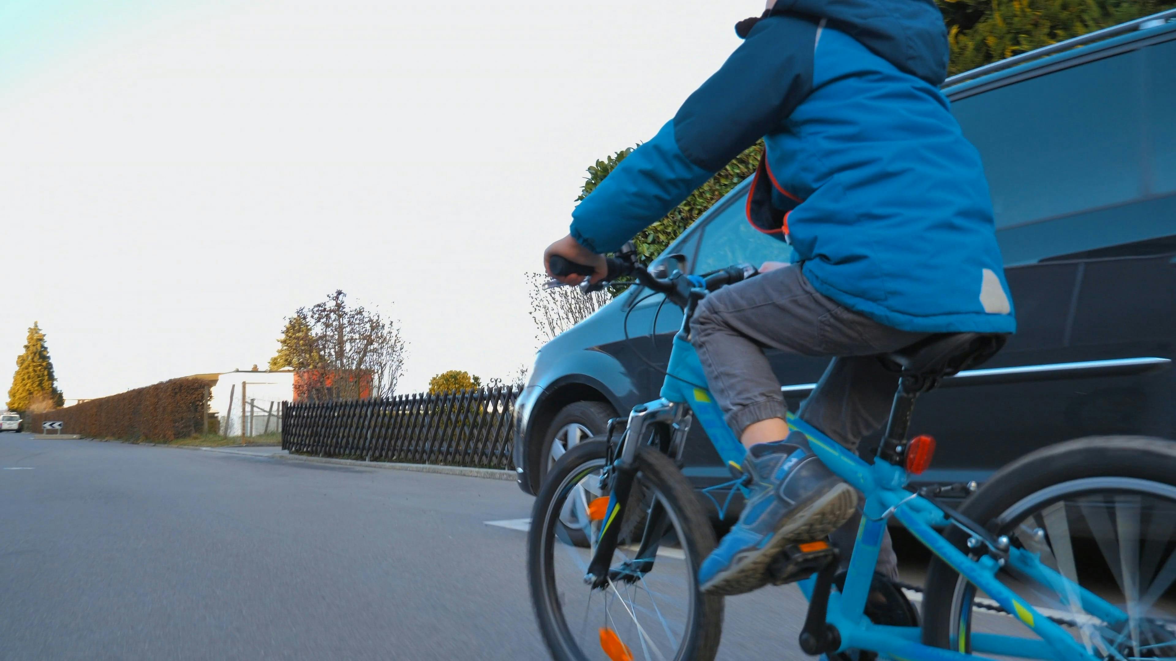 A Young Boy Riding His Bike On A Street Inside The Neighborhood Free ...