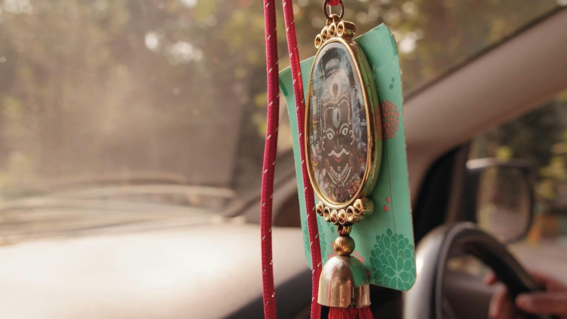 Lucky Charms Decors Hanging On A Car's Rear View Mirror · Free Stock Video