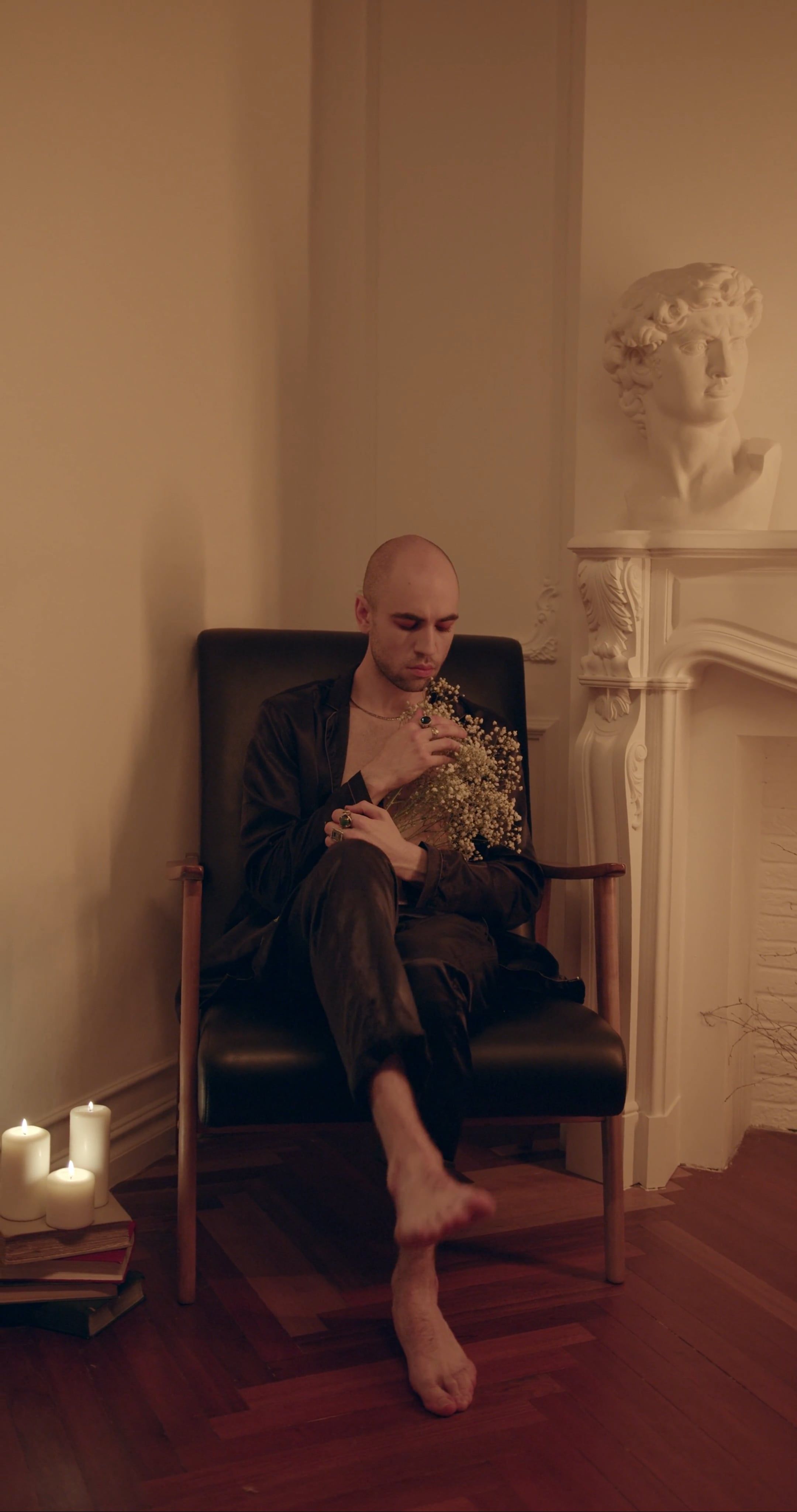 A Man Seated On The Corner Of His Bed In A Darkroom · Free Stock Video
