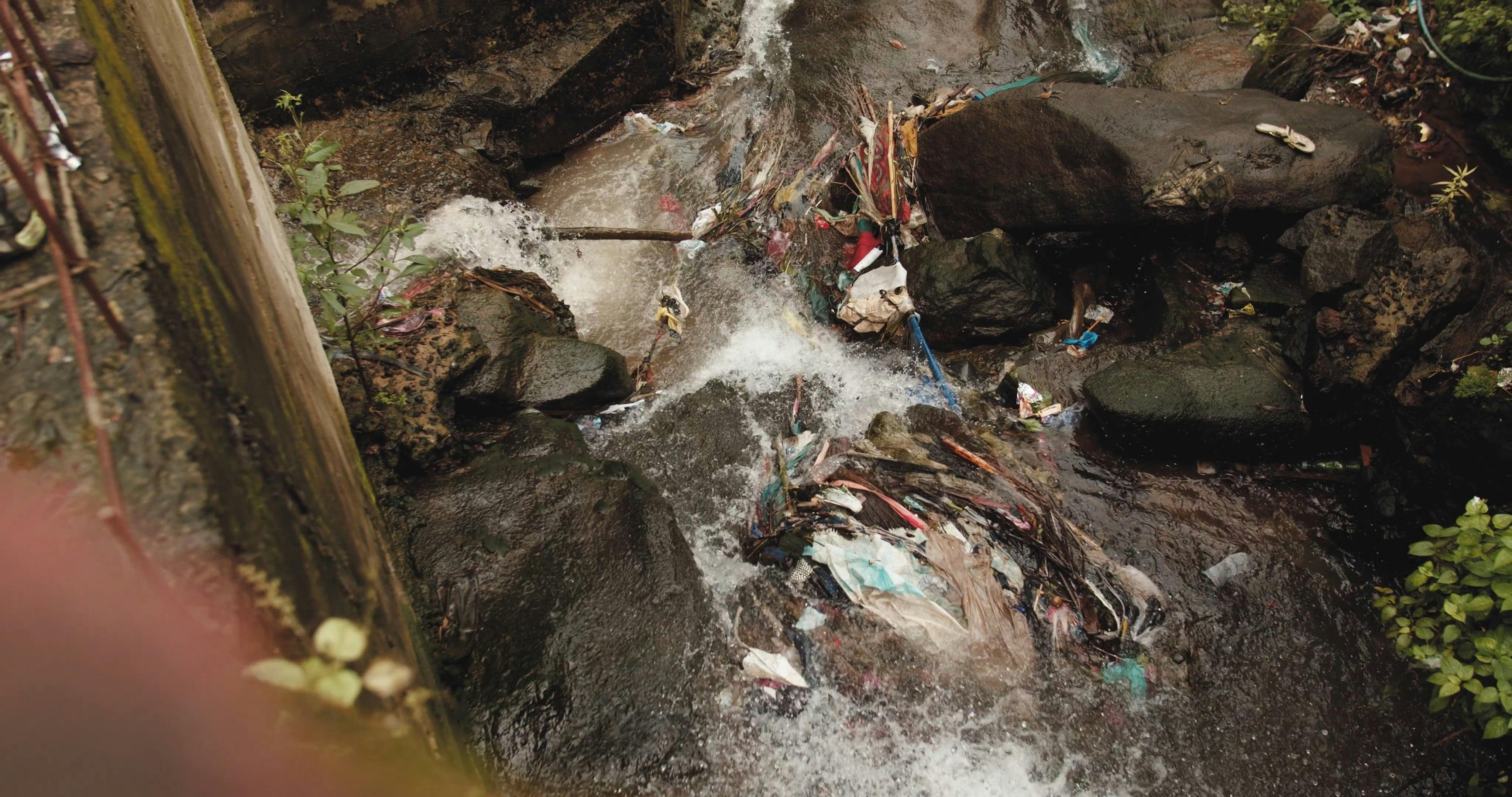 Top View Footage Of A Waterfalls With Garbage · Free Stock Video