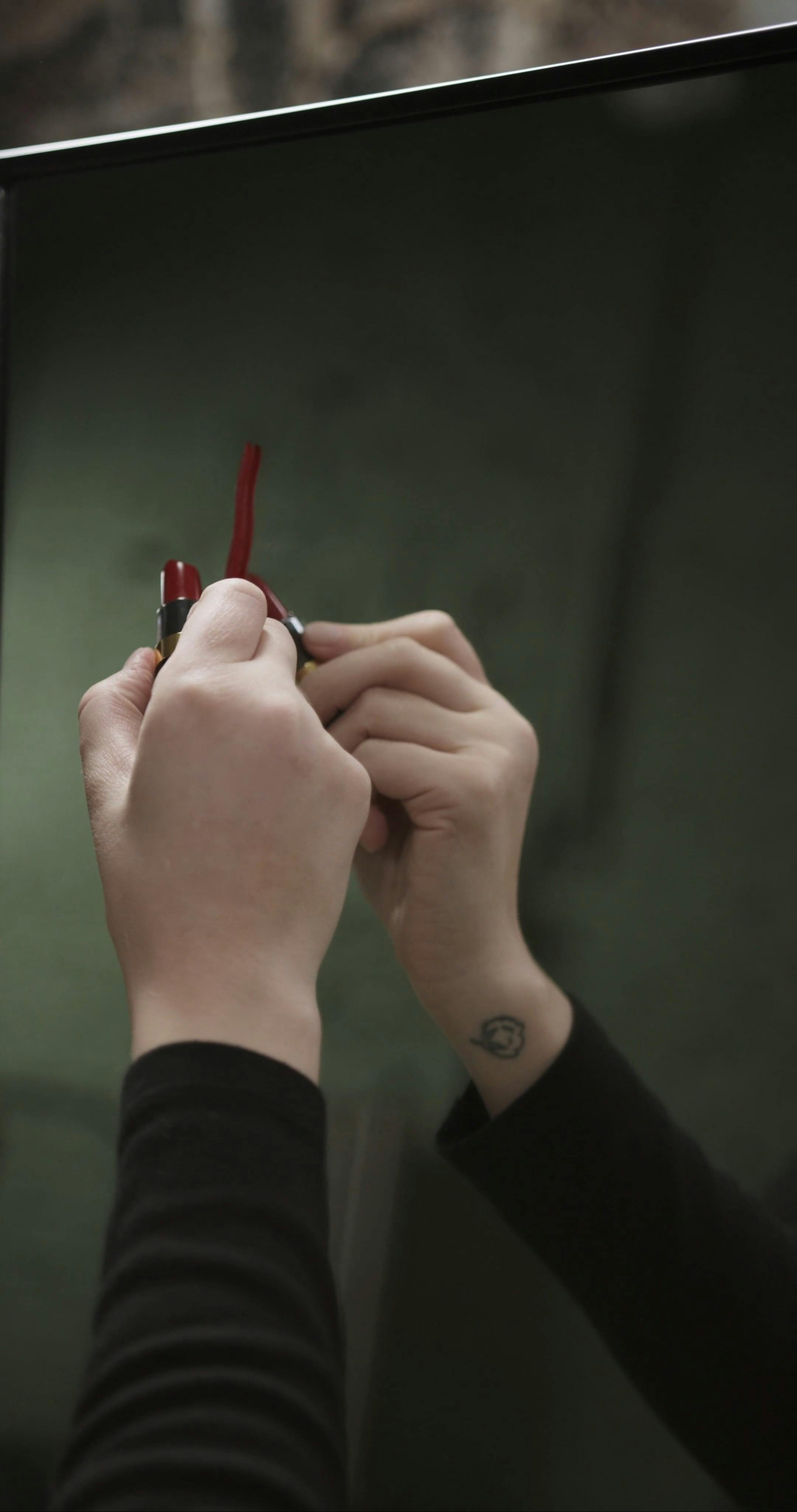 A Woman Writing " Girl Power" On The Mirror Using A Lip Stick Free ...