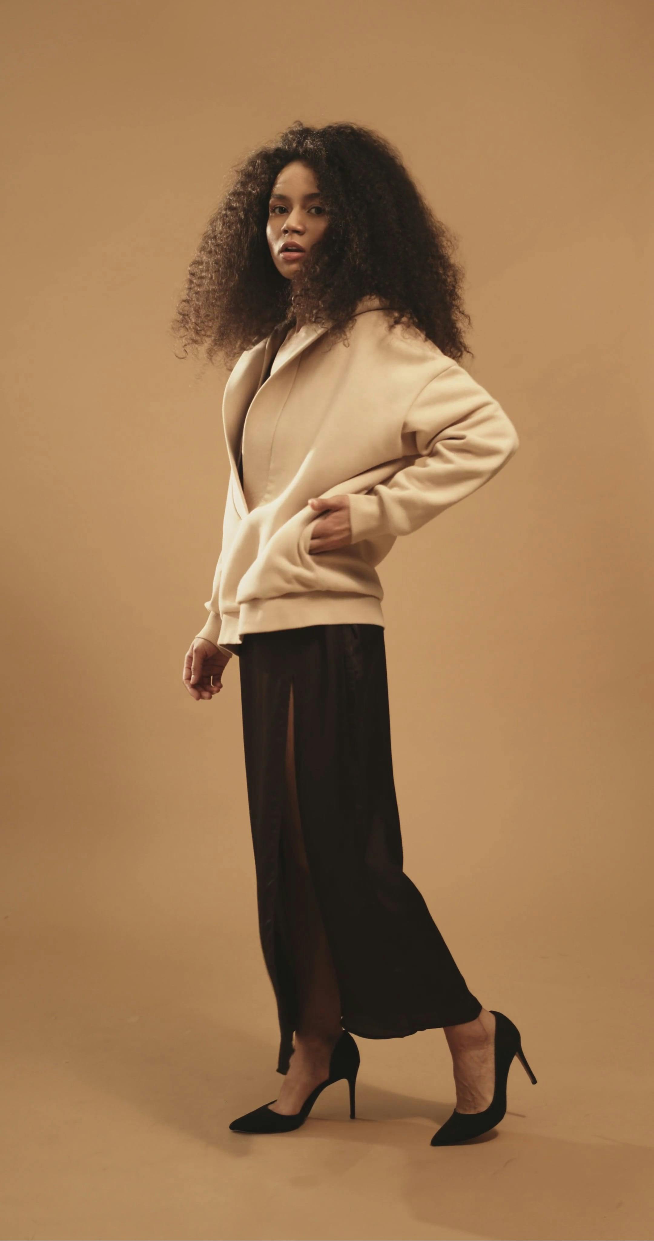 A Woman In Black Dress Topped With A Hoodie Sweat Shirt Poising In A ...