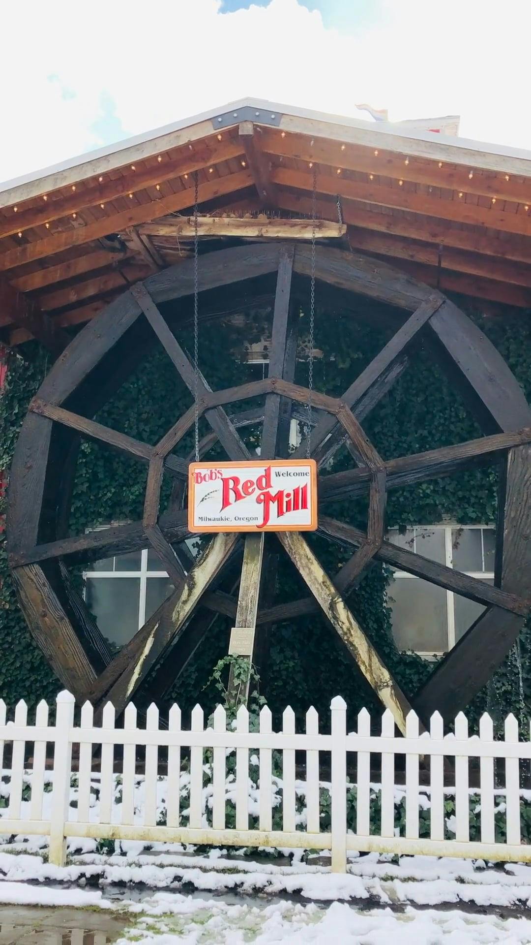A Waterwheel Outside The Store With Red Mill Signage Free Stock Video ...