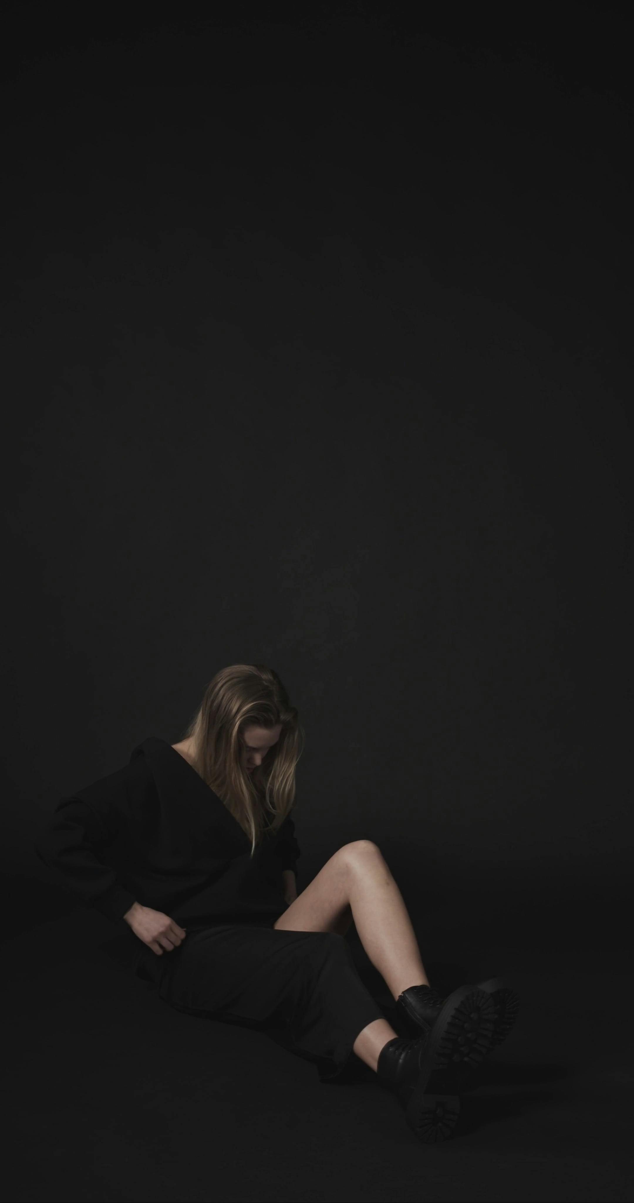 A Model Seated On The Floor Fixing Her Dress And Hair For A Pictorial ...