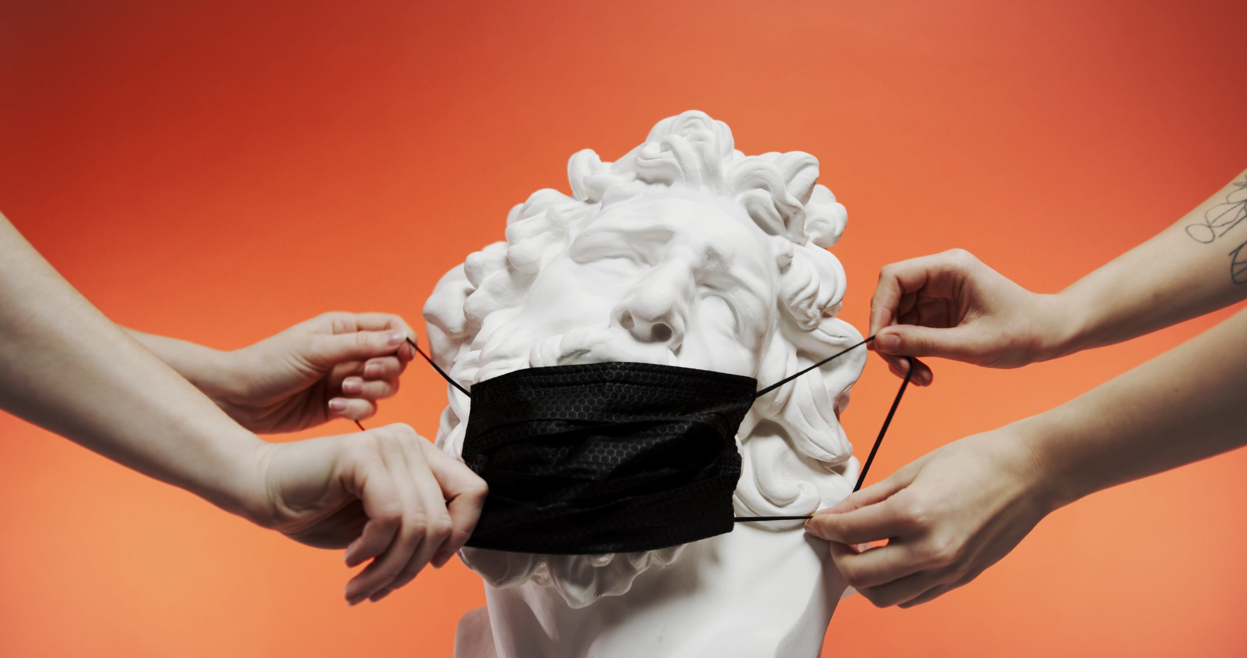 People Placing A Face Mask On A Sculpture Then Falls Off · Free Stock Video