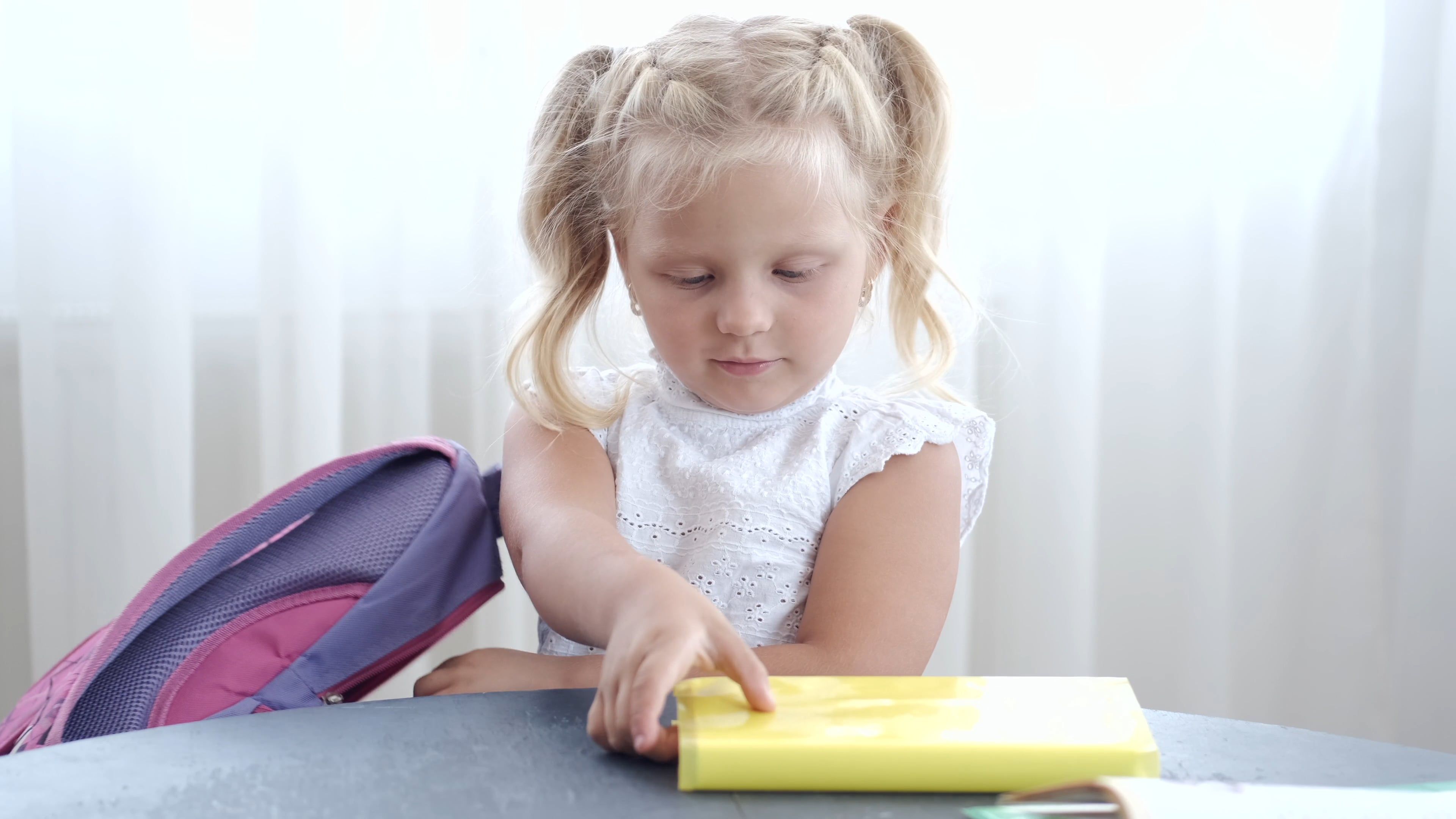 A Young Girl Keeping A Book Inside Her Backpack Bag Free Stock Video ...