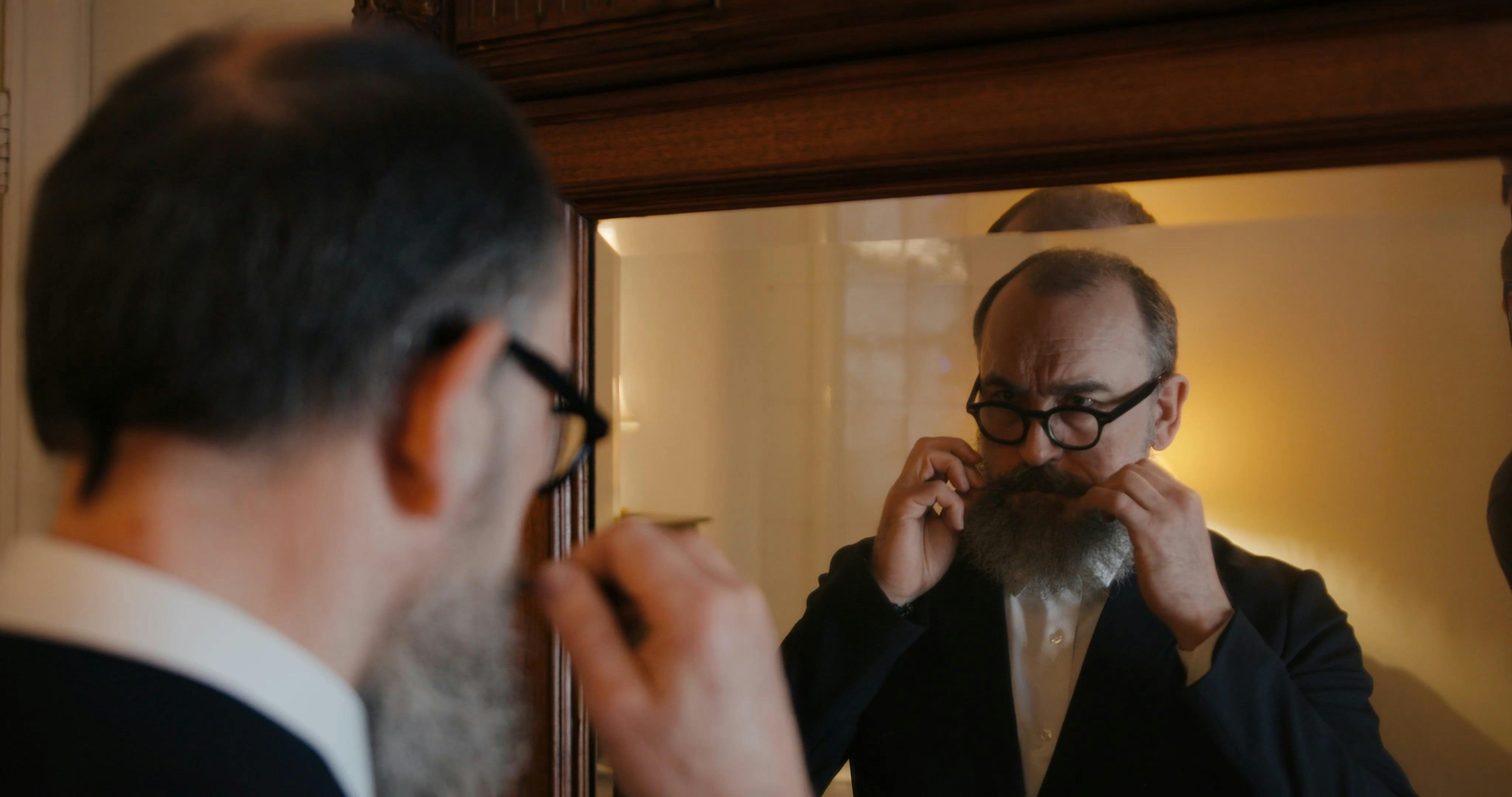 An Jewish Grooming His Moustache And Wearing His Kippah Looking At A ...
