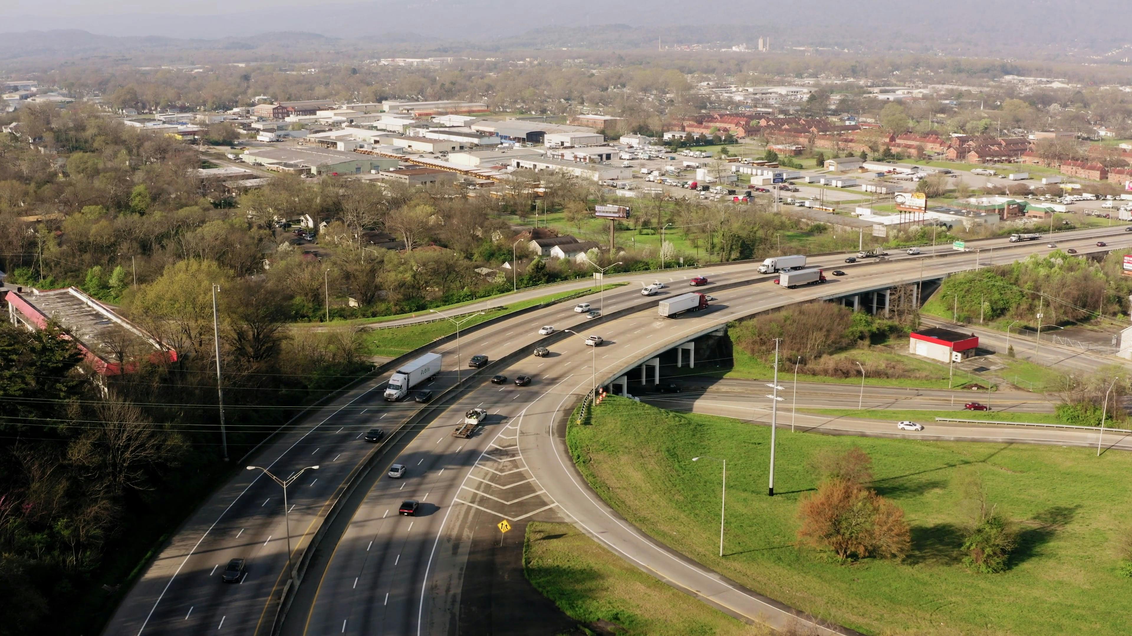 Drone Footage Of A Highway Passing Through A Town · Free Stock Video