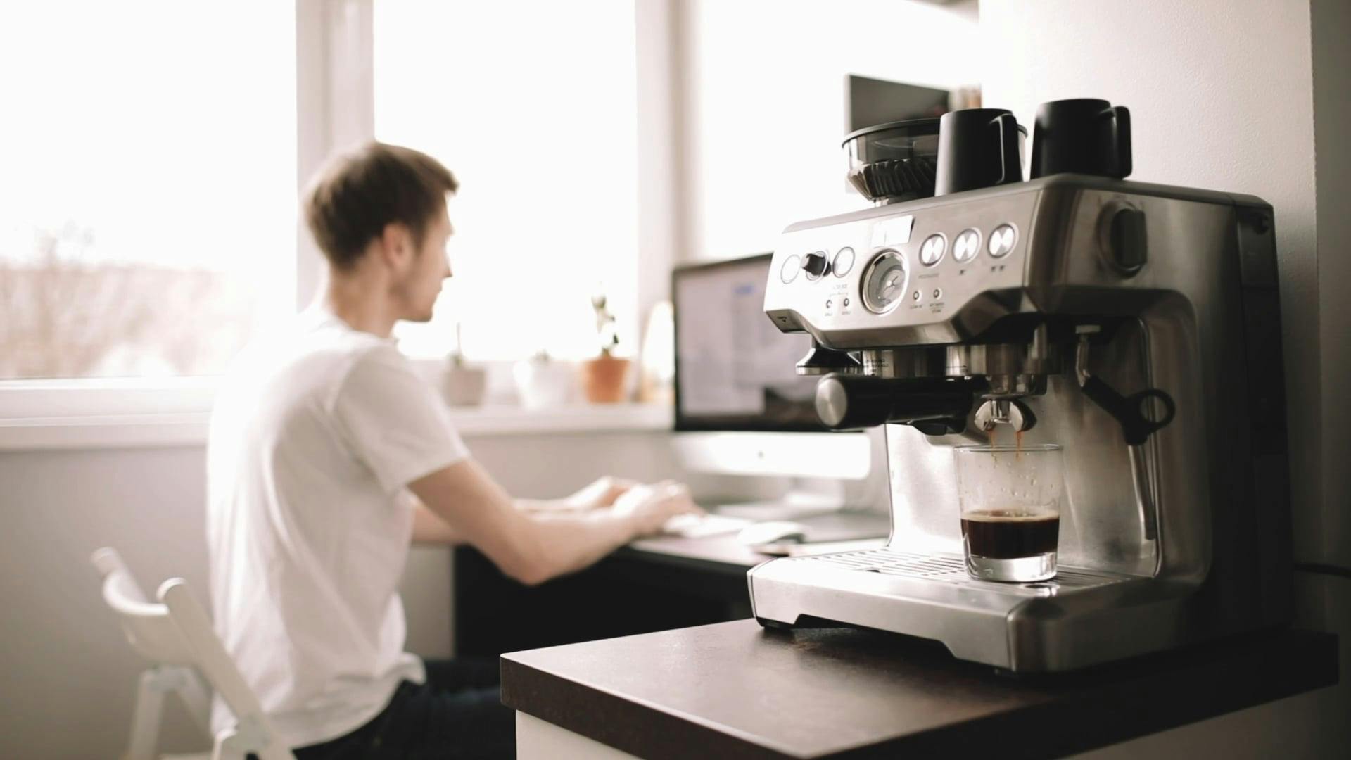 A Man Typing while Waiting for his Coffee in the Coffee Machine · Free ...