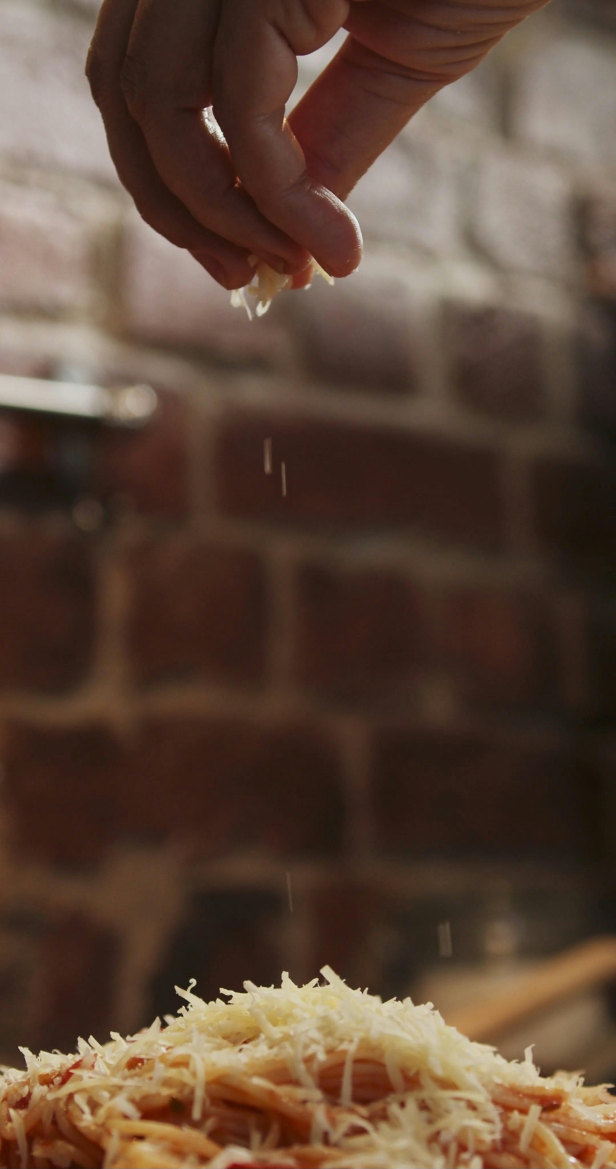 Sprinkling Cheese On Spaghetti · Free Stock Video