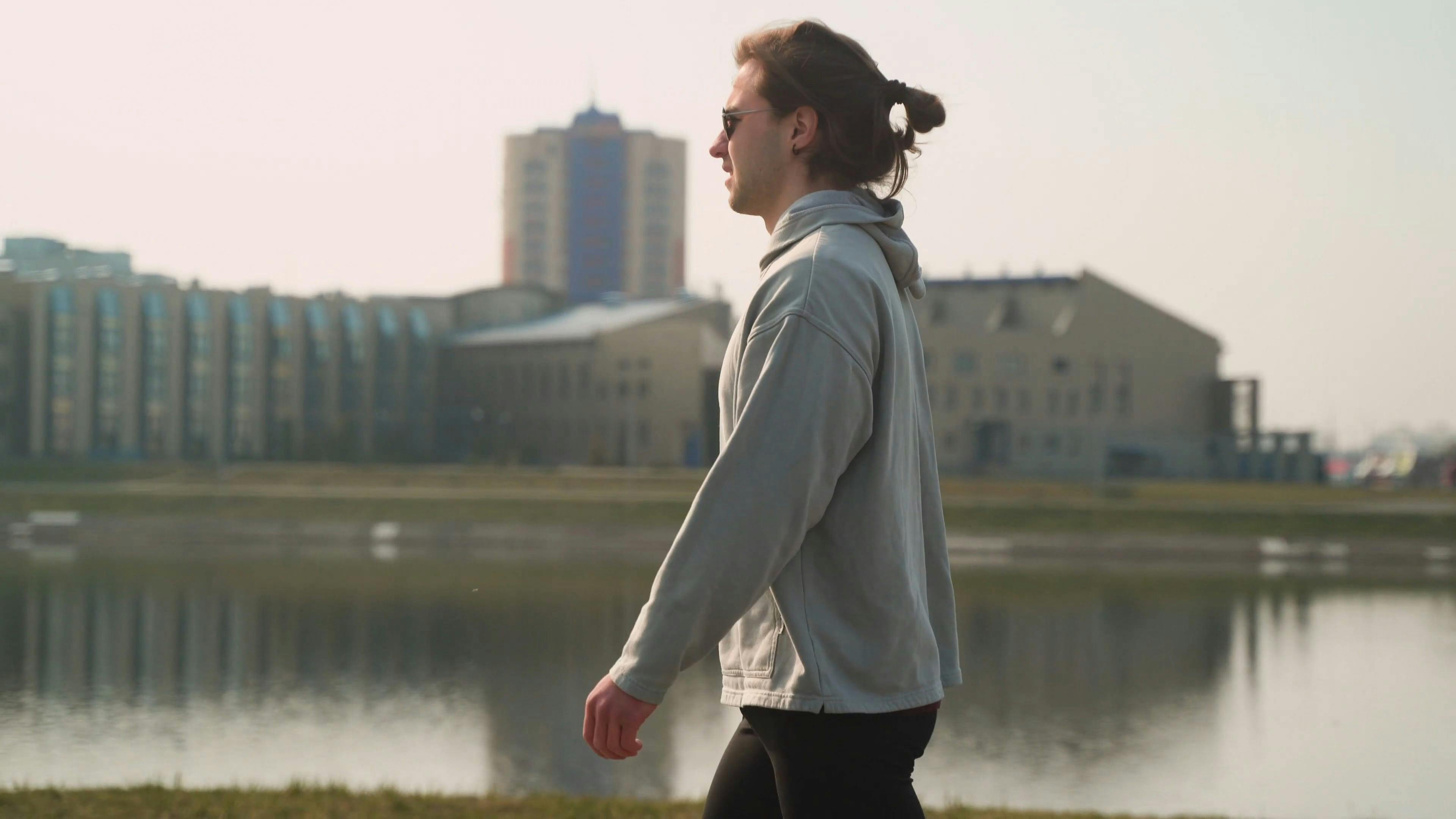 A Man Jogging in the Street near the Lake Free Stock Video Footage ...