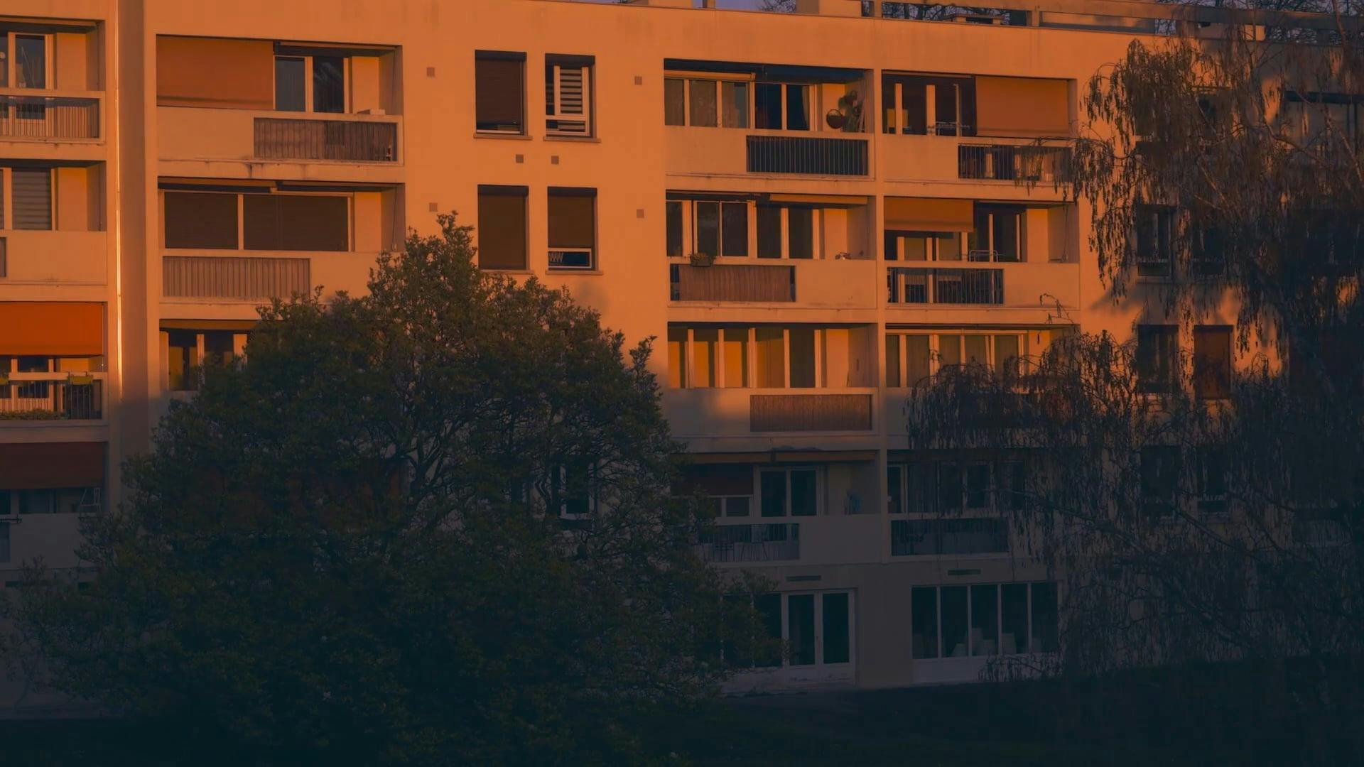 Time-lapse of Sunset Shinning on an Apartment Building Front Free Stock ...