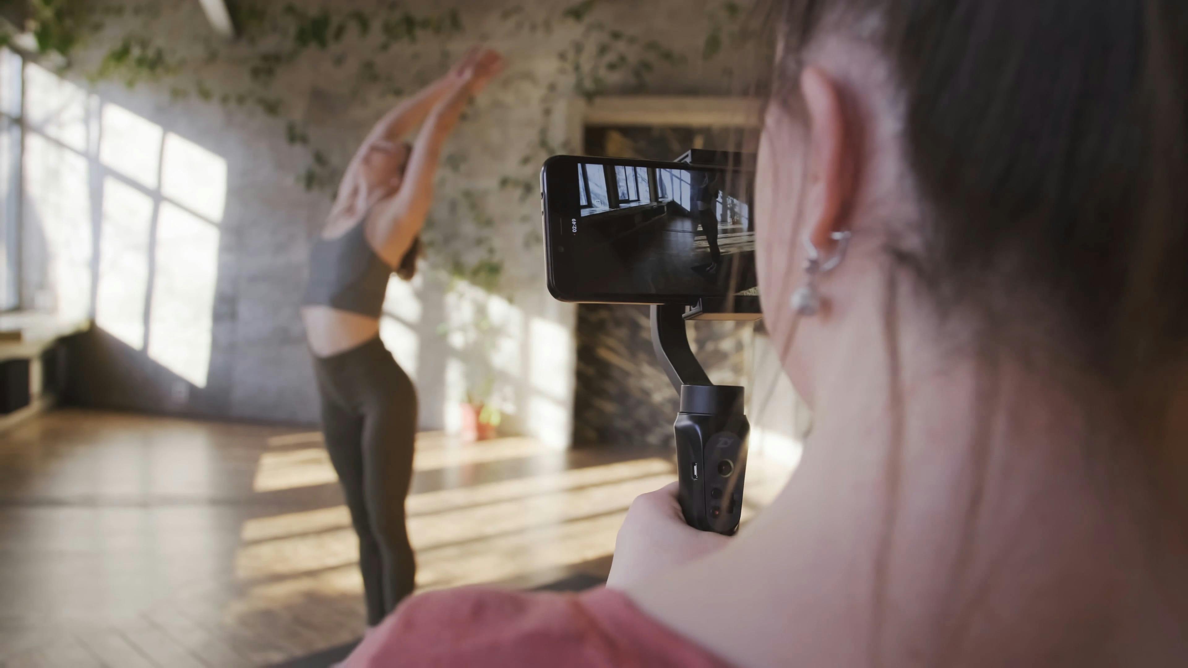 A Woman Taking Video of a Woman Doing Yoga Free Stock Video Footage ...