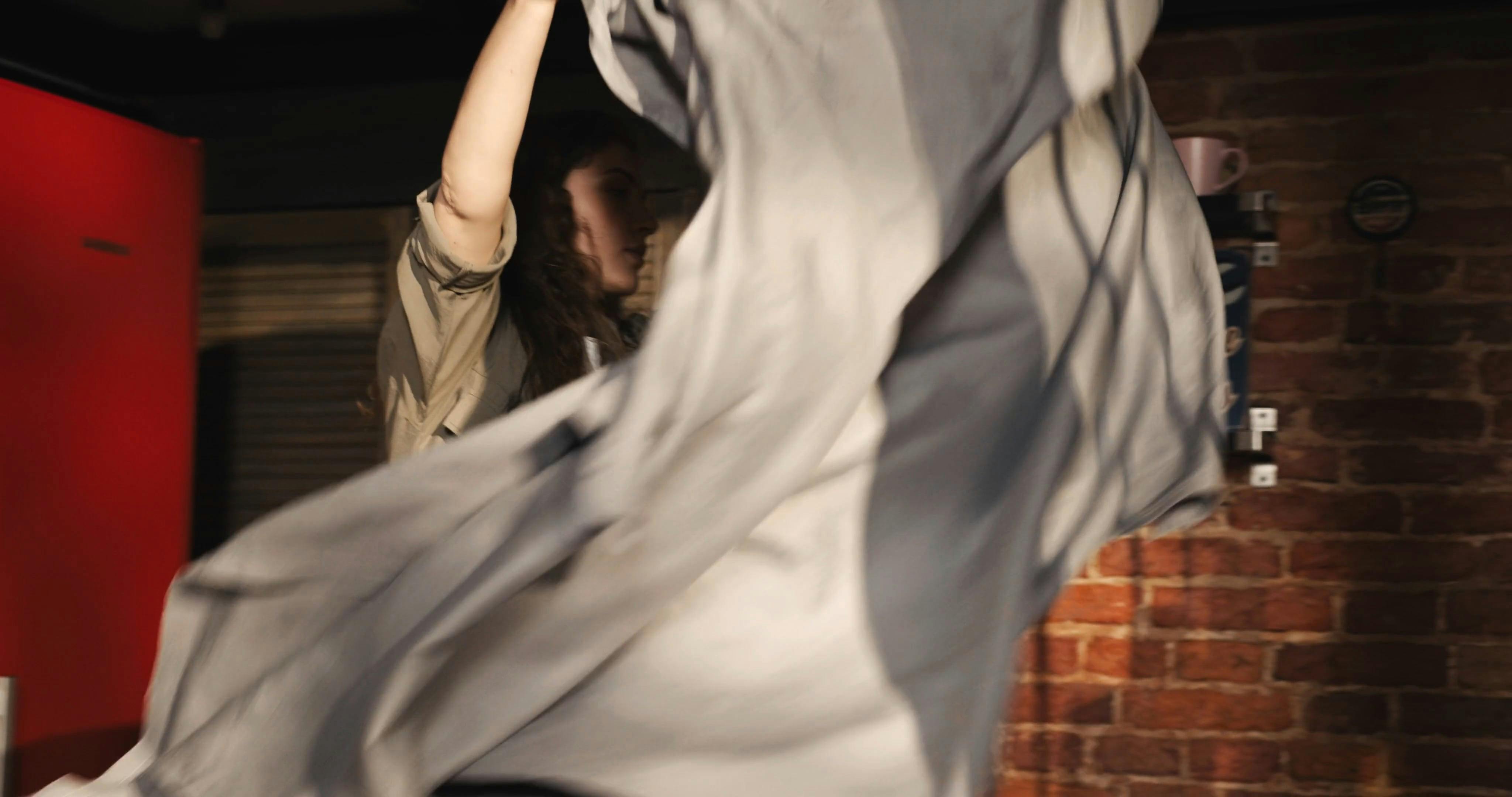 A Woman Covering The Dining Table With Table Cloth And Setting Up The ...
