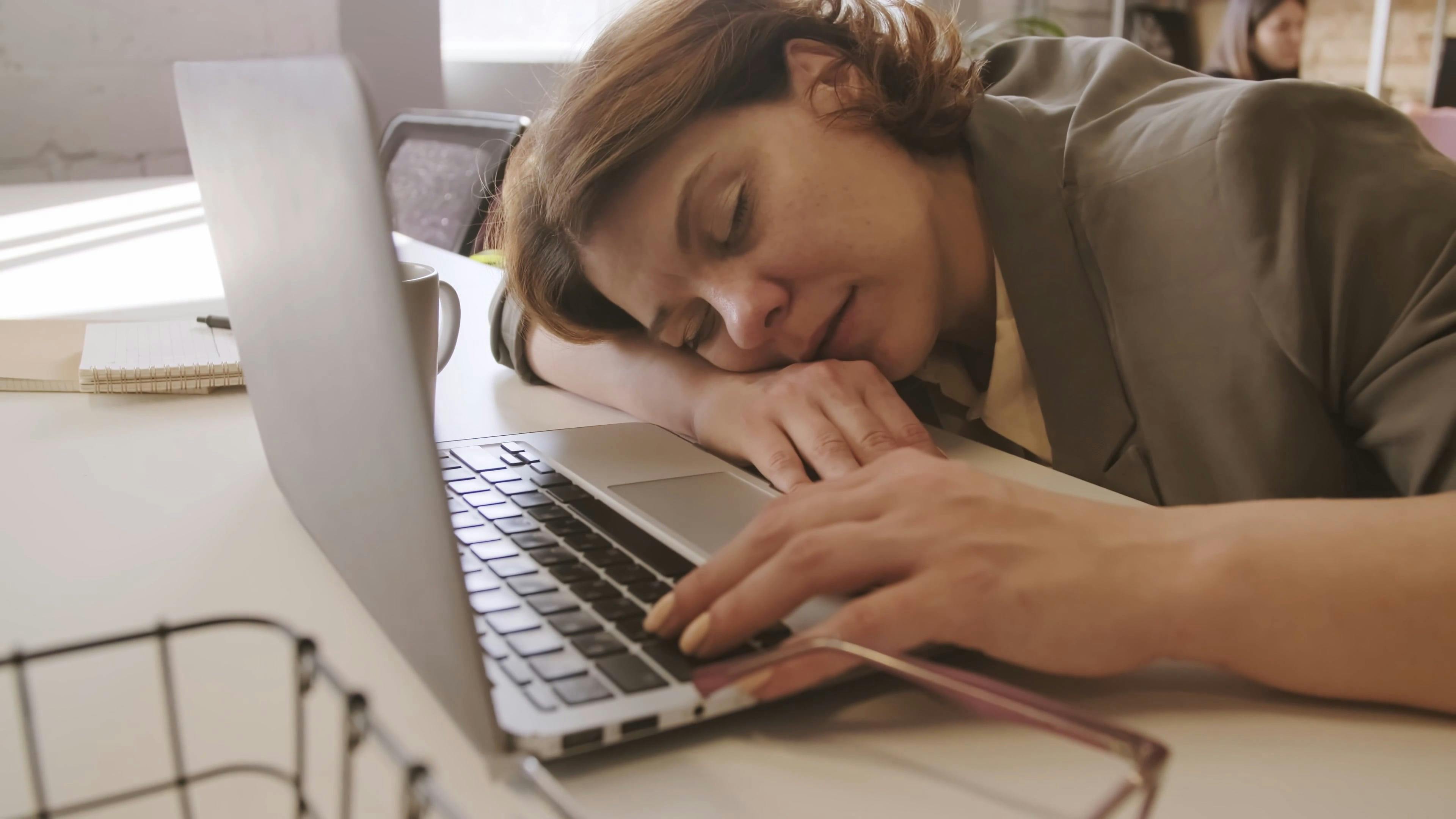 A Woman Sleeping beside her Laptop while Sitting Down · Free Stock Video
