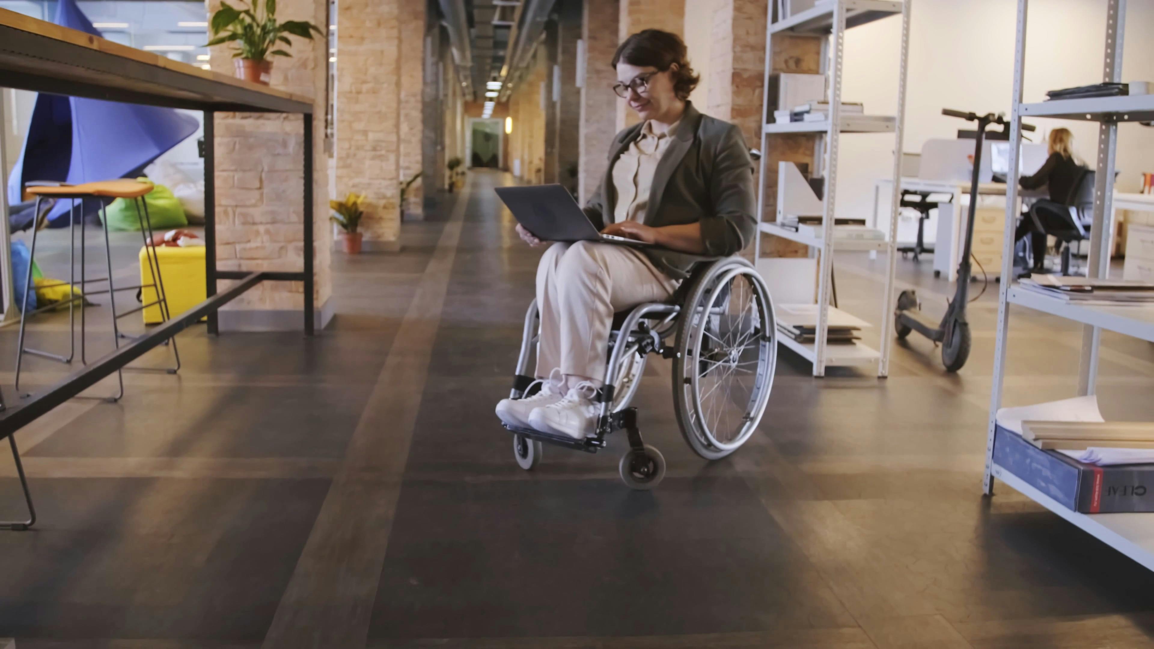 A Woman on a Wheelchair Using a Laptop · Free Stock Video
