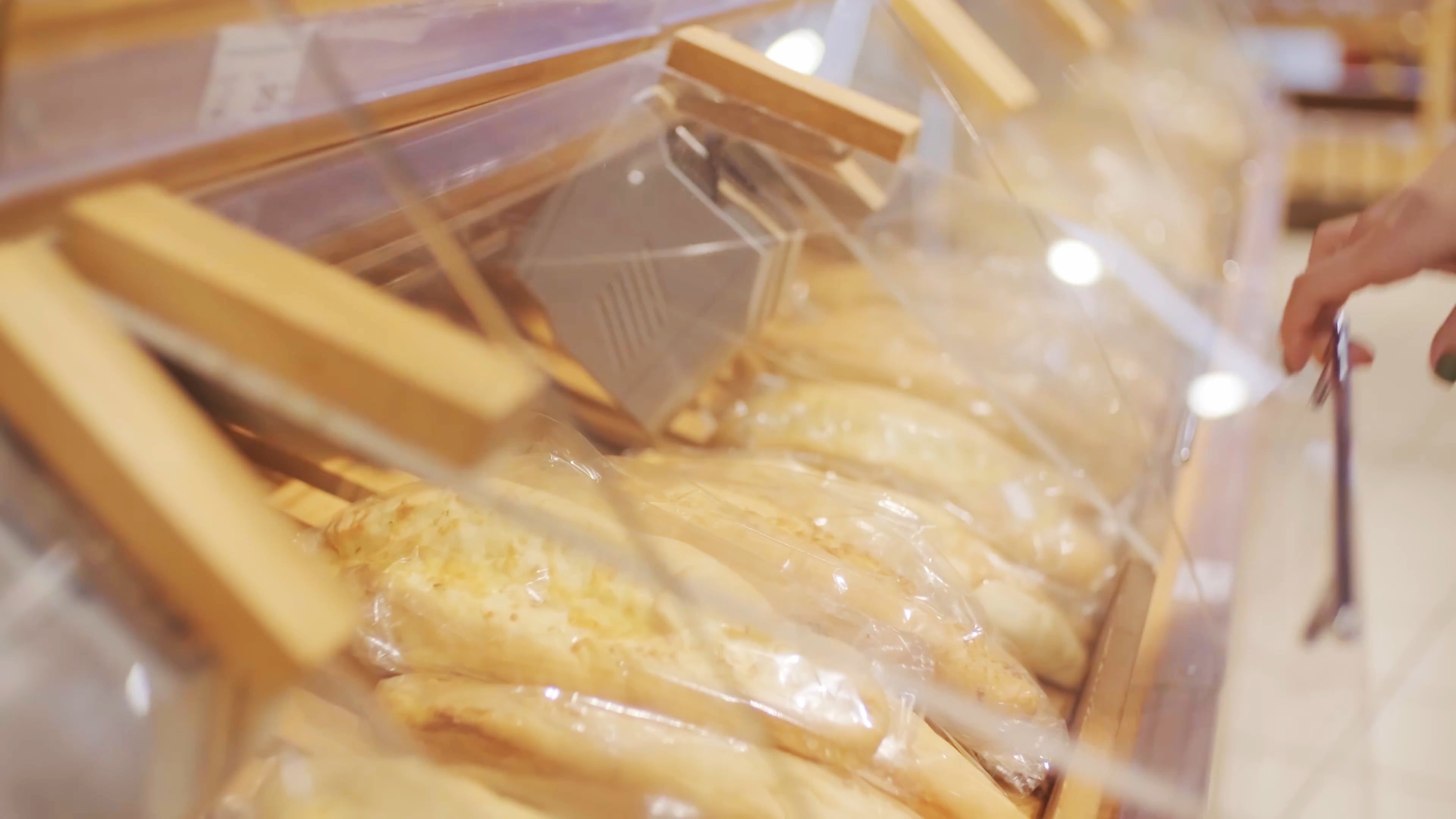 A Woman Picking Bread in the Grocery · Free Stock Video