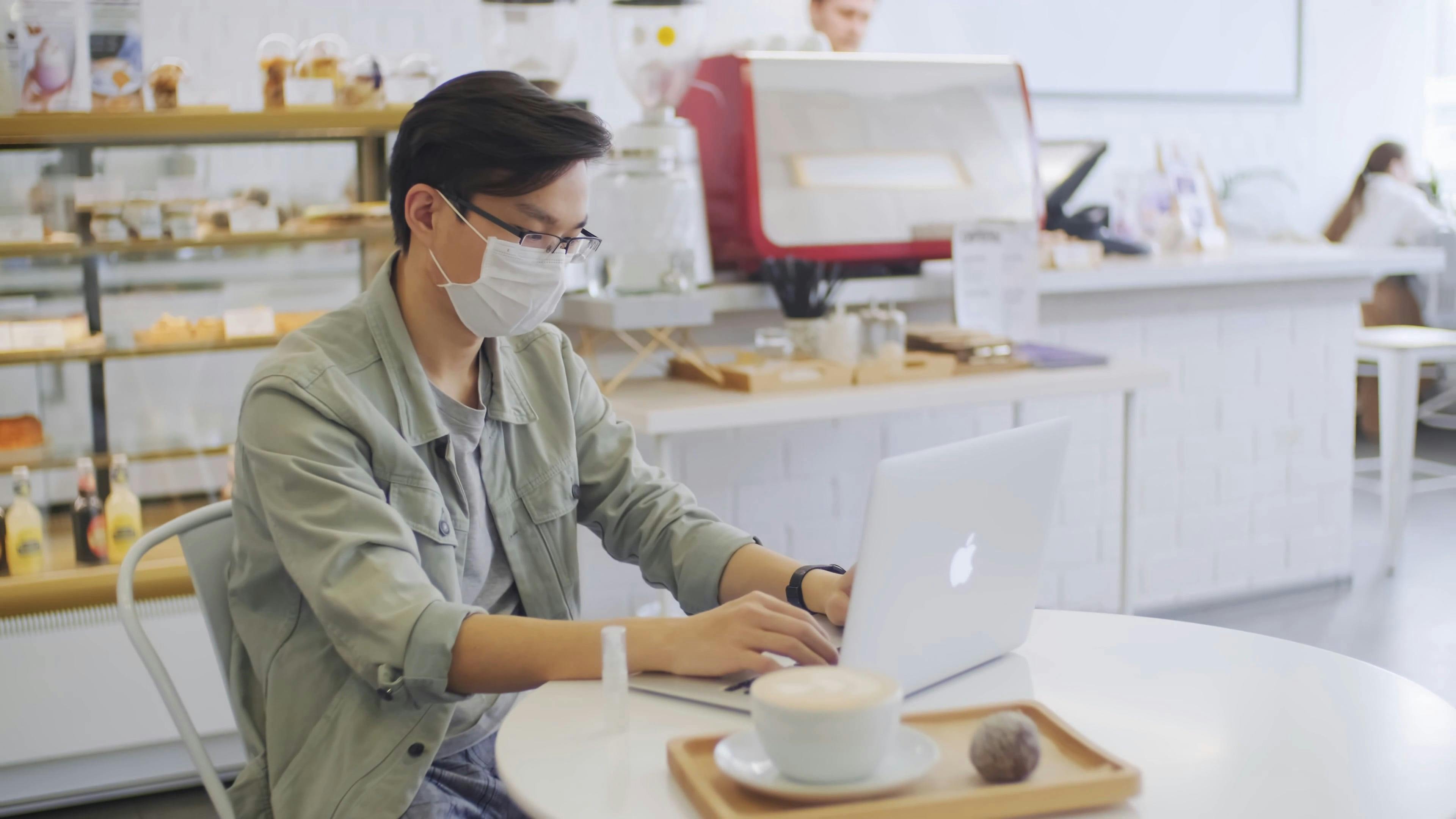 A Man Using the Laptop in the Cafe · Free Stock Video