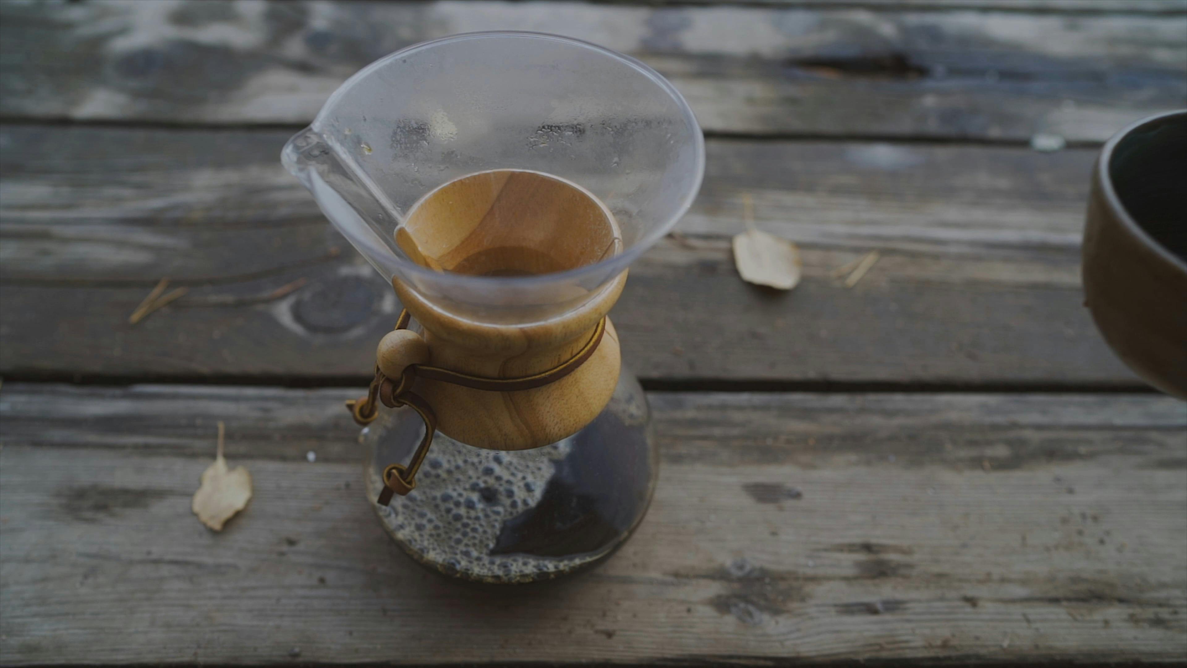A Person Putting Cup Beside the Chemex on the Table Free Stock Video ...