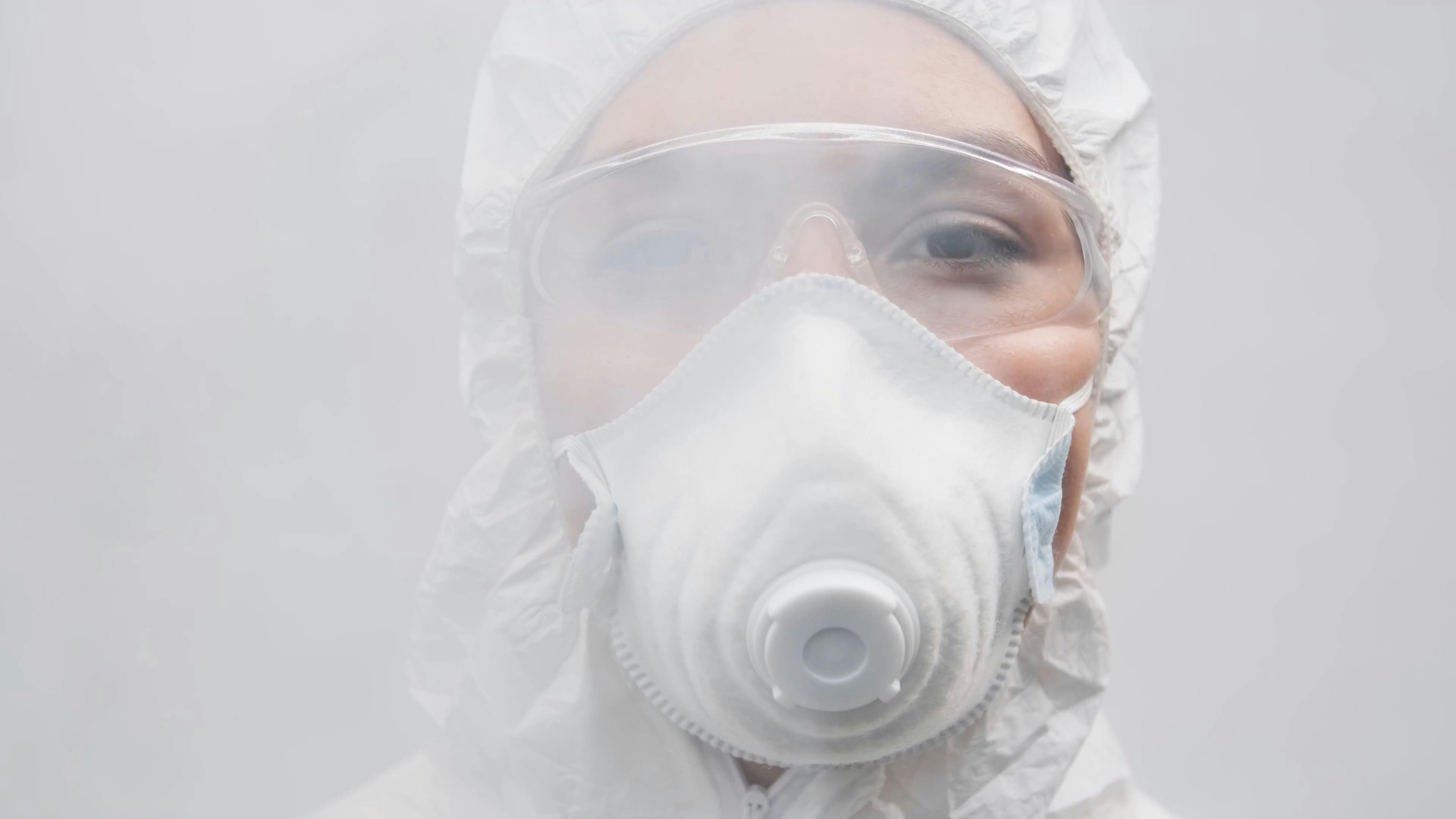 A Person in a Protective Suit Putting On a Goggles · Free Stock Video