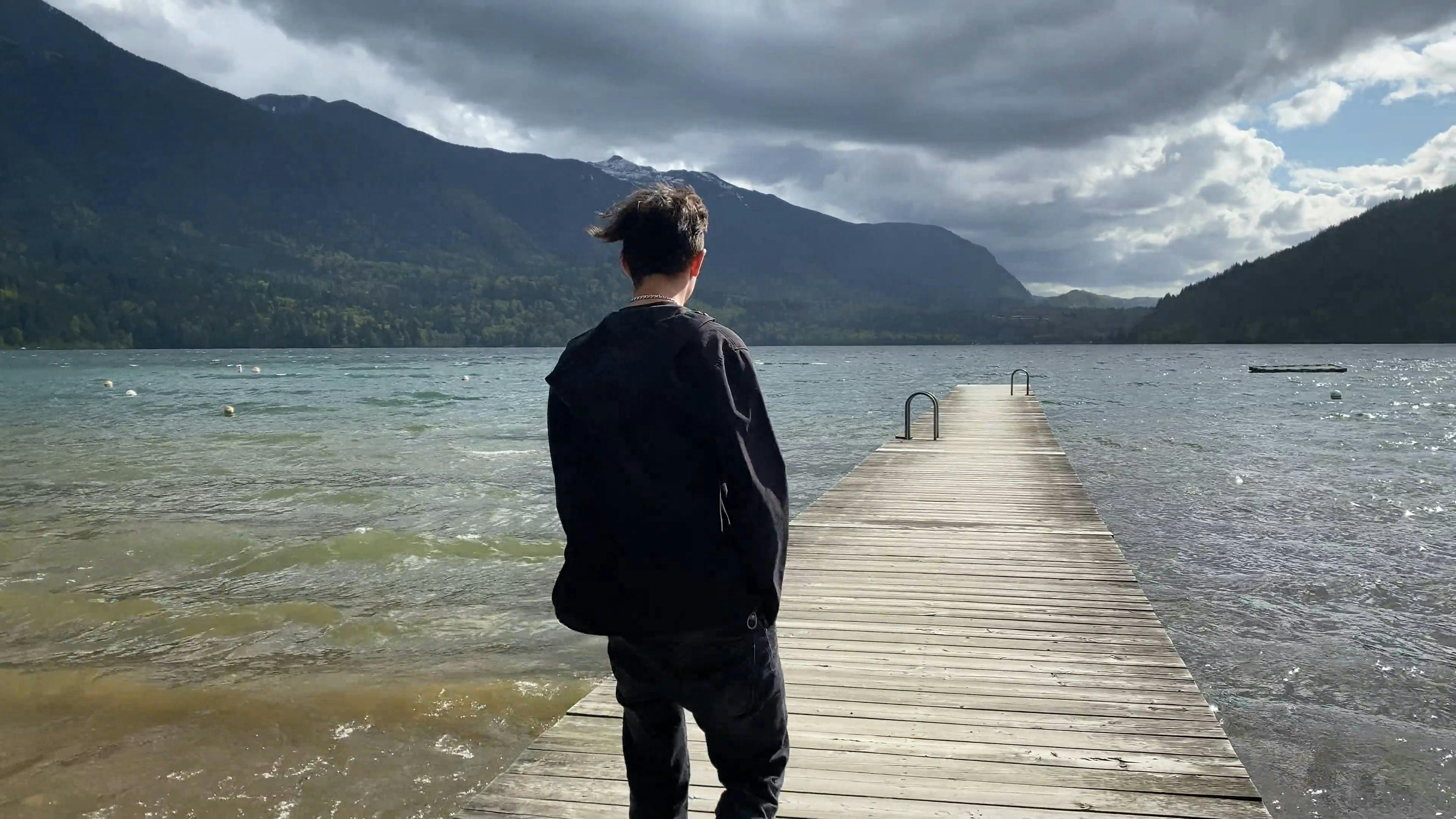 A Man Walking Om A Wooden Dock Above The Lake · Free Stock Video