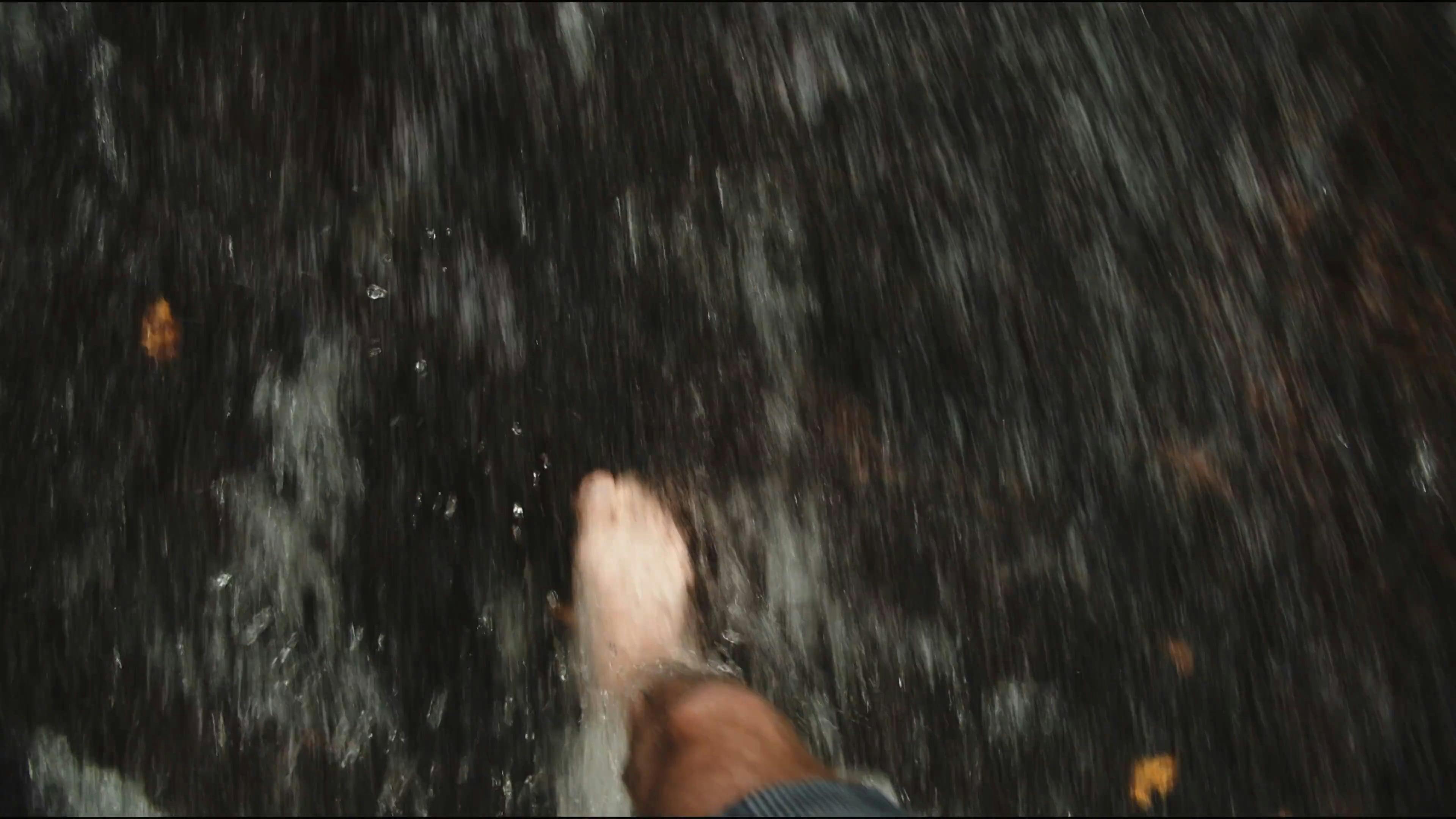 Person Walking On The River Stepping On Rocks · Free Stock Video