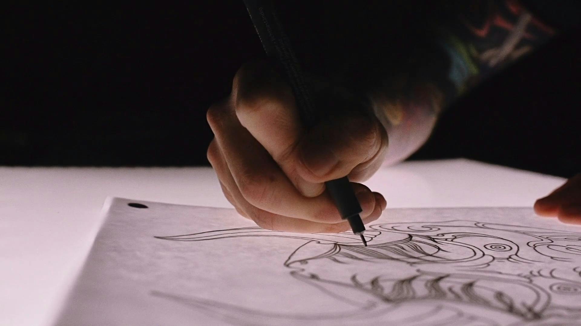 A Tattoo Artist Drawing A Tattoo Design · Free Stock Video