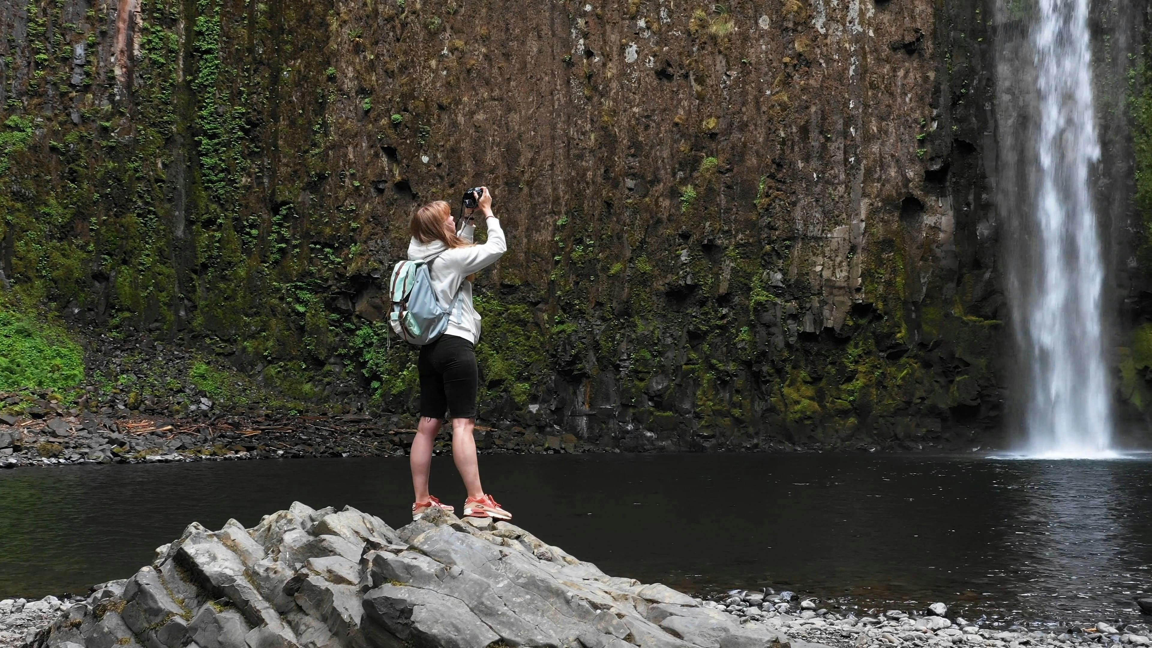 A Woman Taking Photo Of A Waterfalls · Free Stock Video