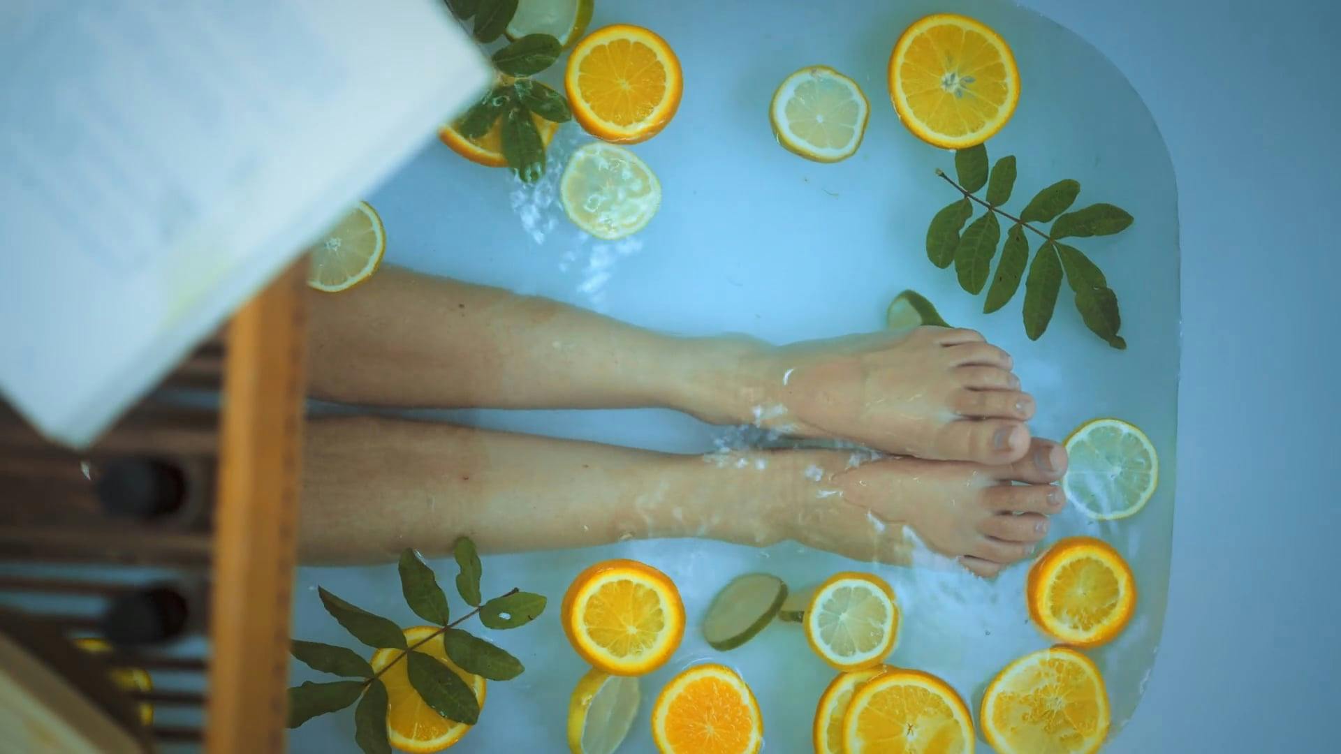 A person's feet in a bath with oranges and lemons Free Stock Video ...
