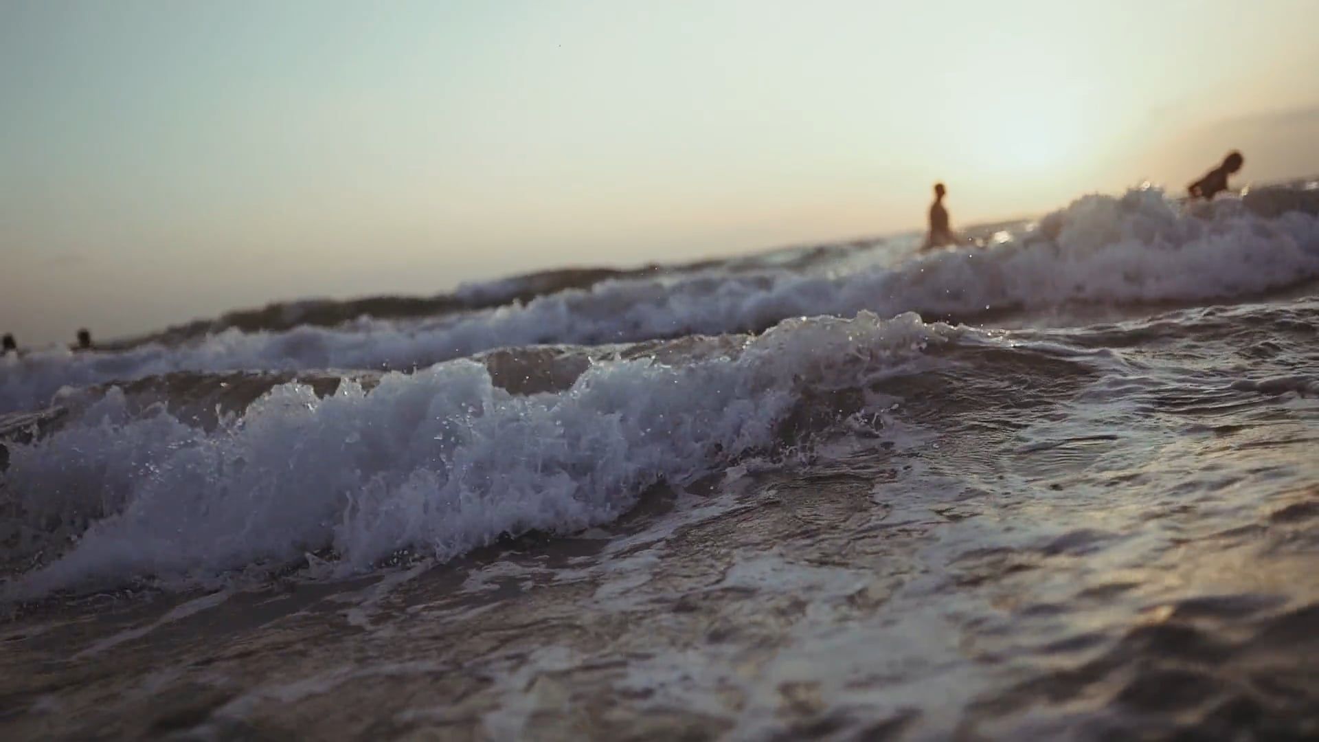 A person surfing in the ocean at sunset Free Stock Video Footage ...