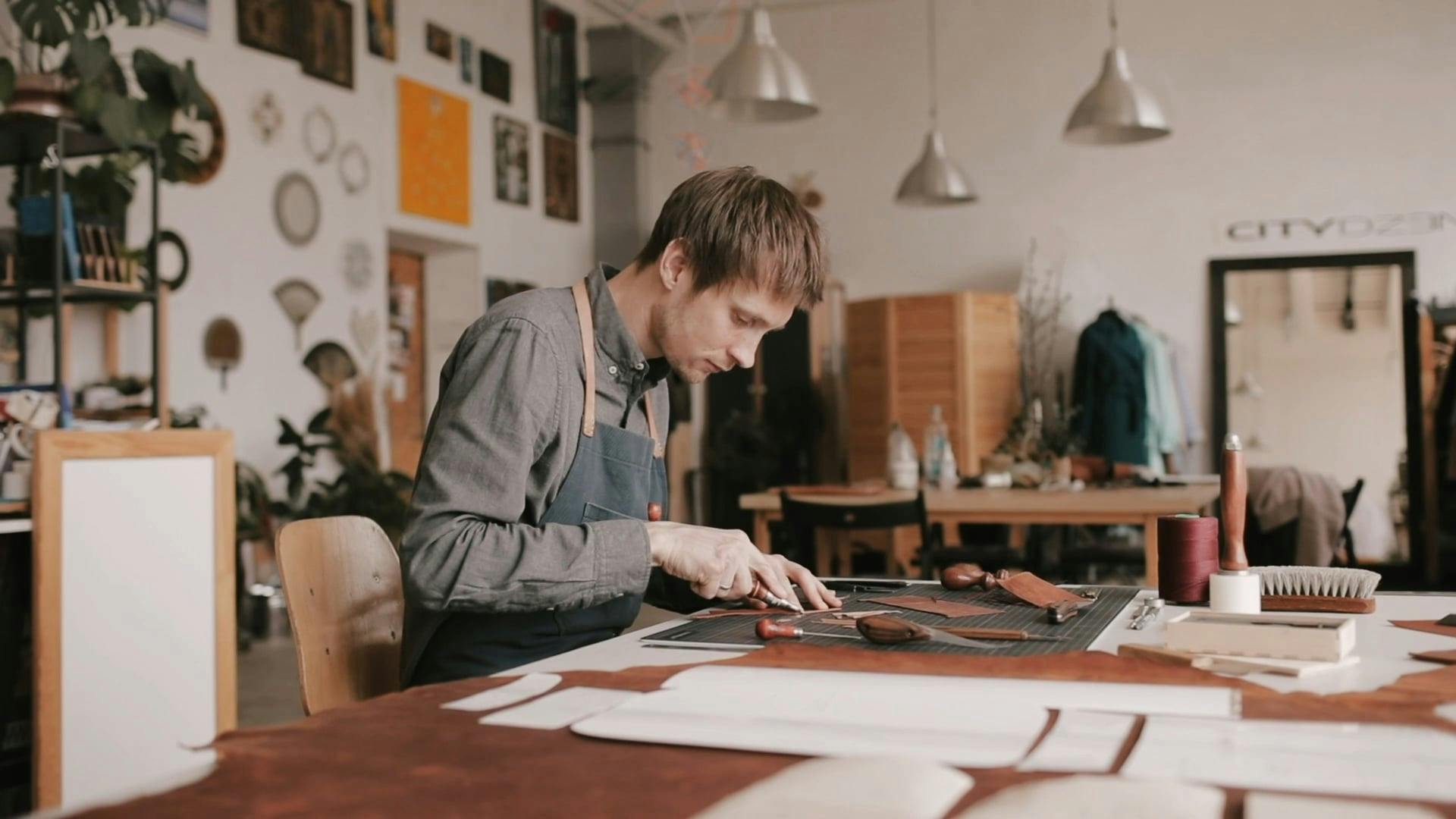 A Male Leatherworker Working at a Table · Free Stock Video