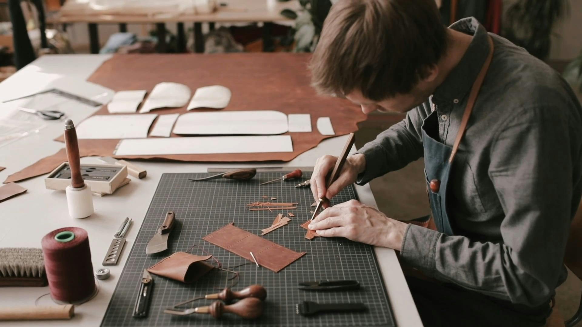 A Male Leatherworker Working at a Table · Free Stock Video