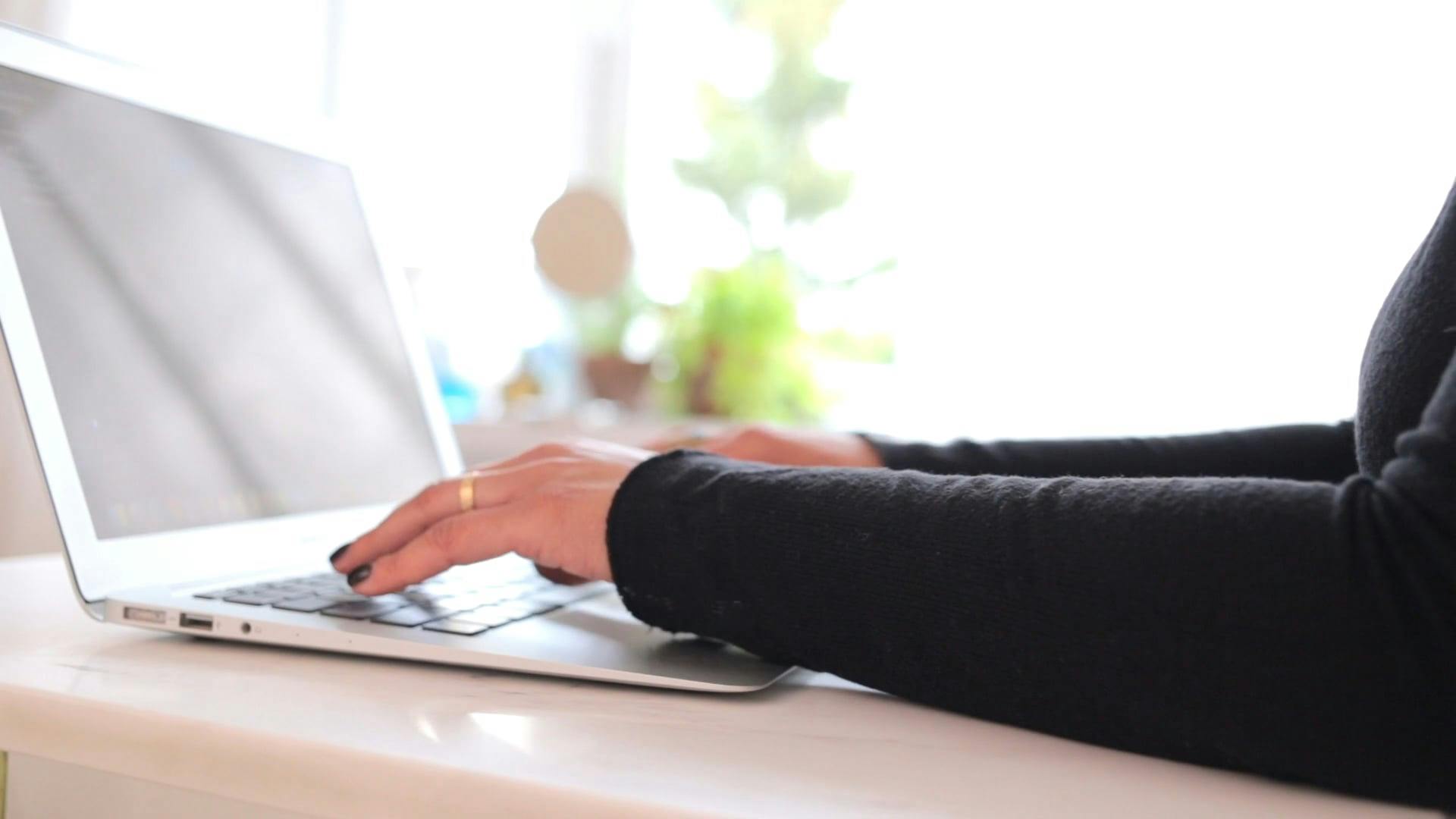 Person Using Her Macbook · Free Stock Video