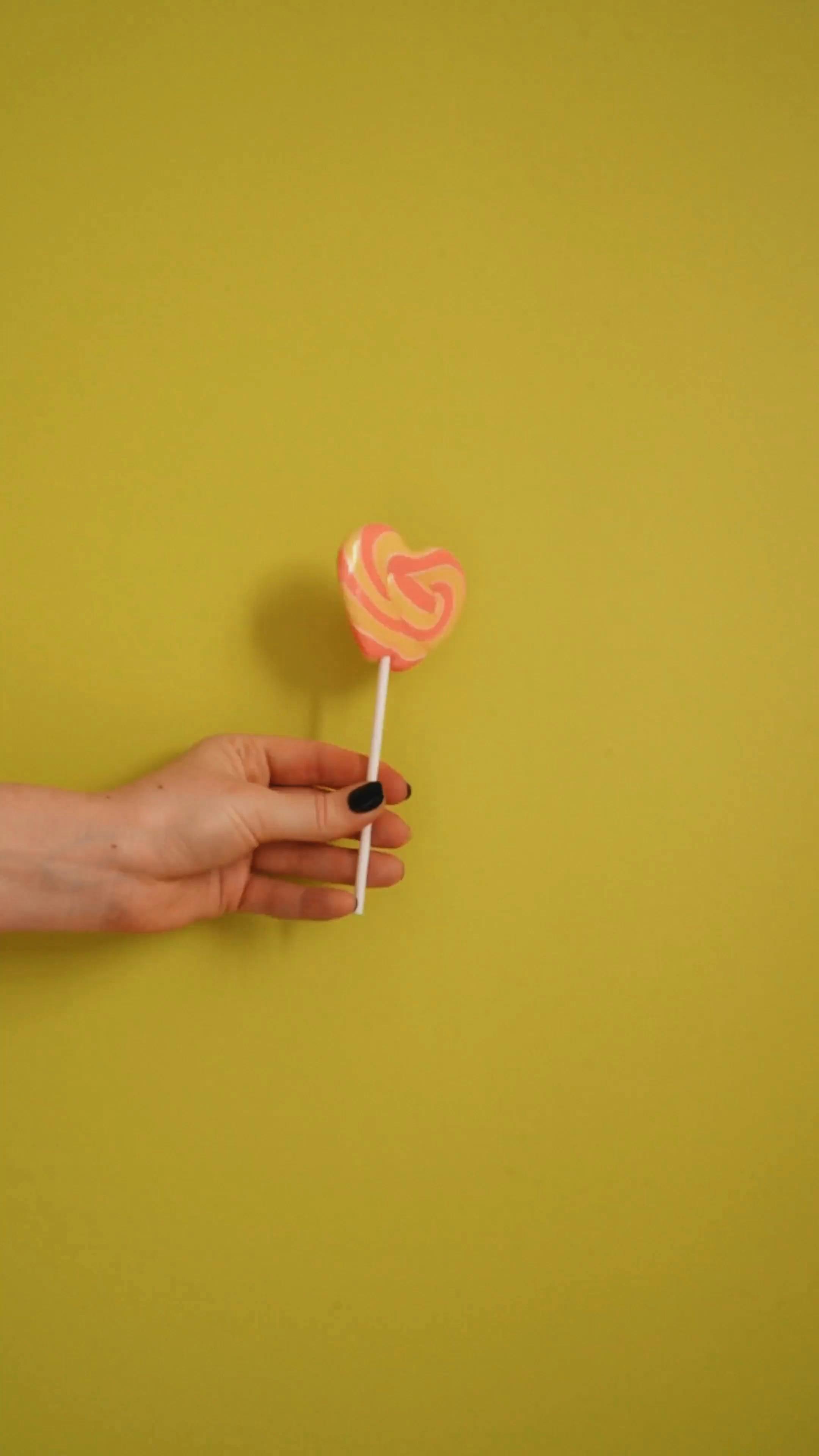 Rolling A Lollipop Through The Fingers · Free Stock Video