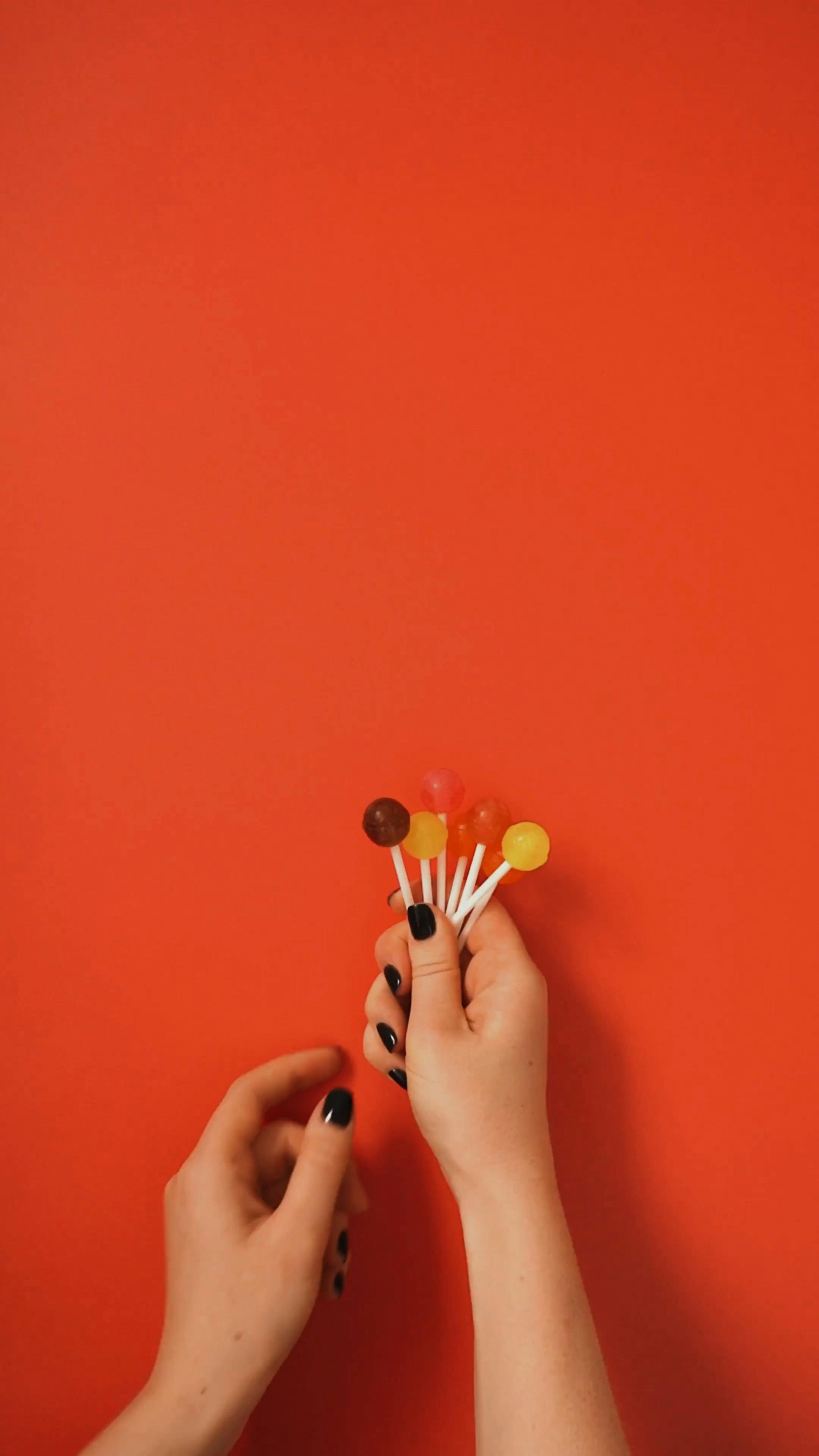 Close Up View of a Person Holding a Lollipop Free Stock Video Footage ...