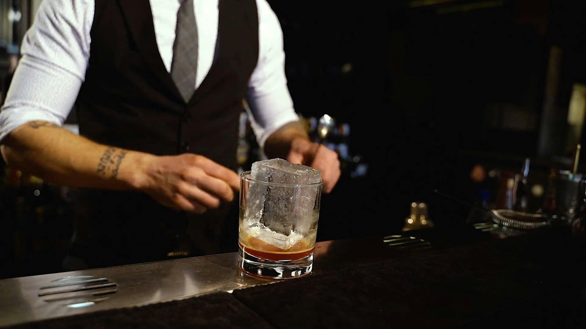 A Bartender Stirring an Ice Cube in a Glass Free Stock Video Footage ...