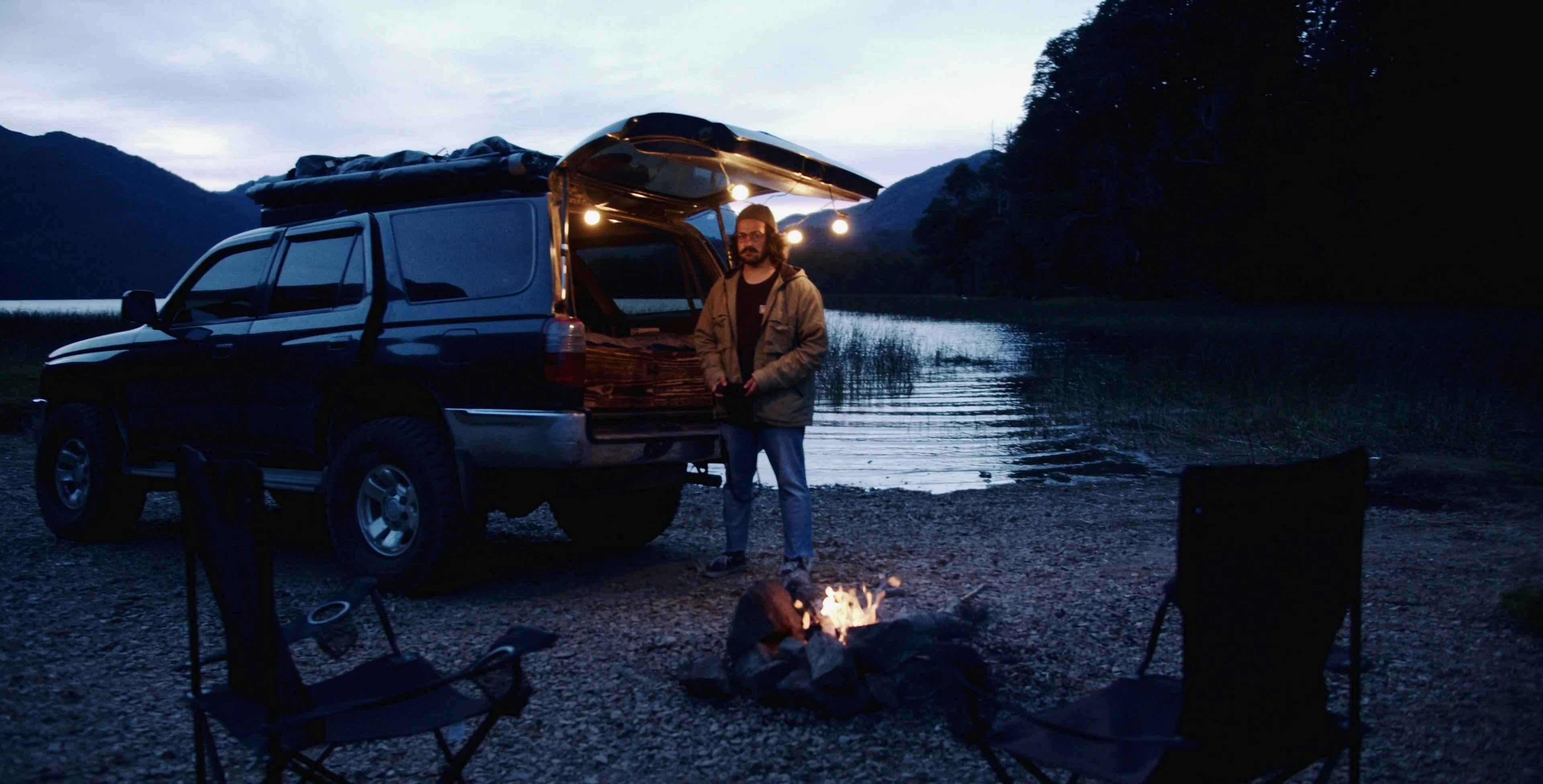 A Man Camping By The Lakeside Taking Photos Of Natures Beauty · Free ...