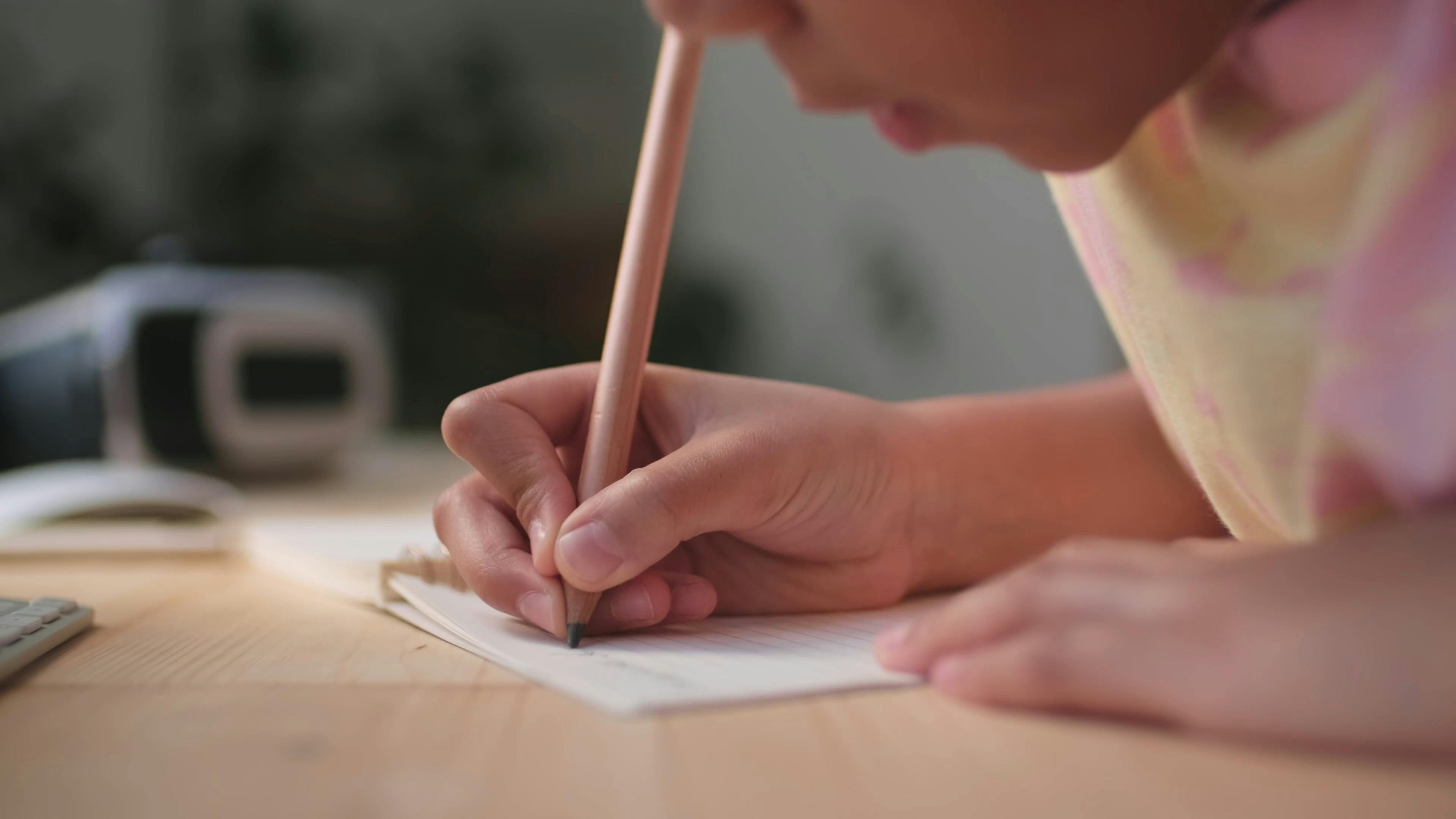 Child Writing On A Notebook · Free Stock Video