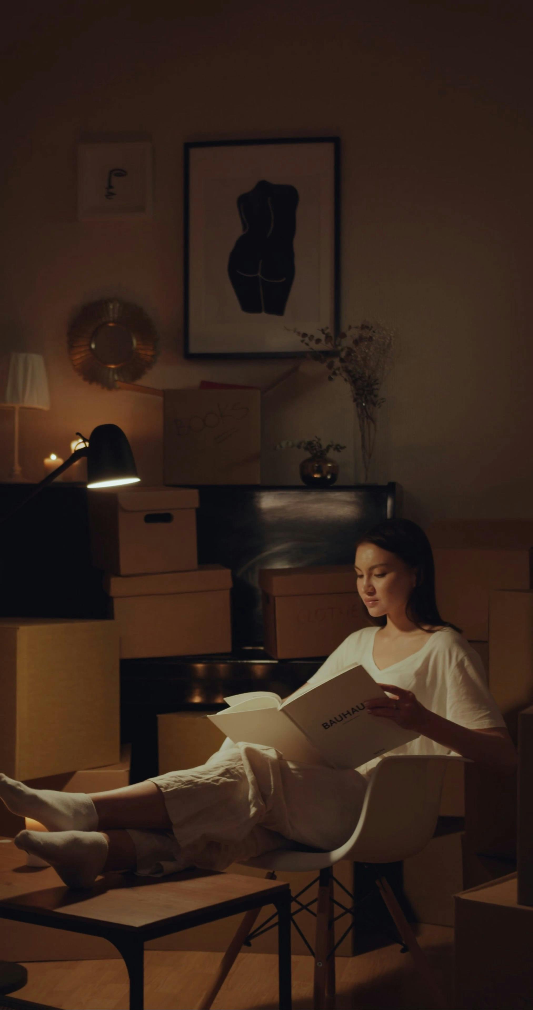 A Woman Reading A Book Under The Lamp Light · Free Stock Video