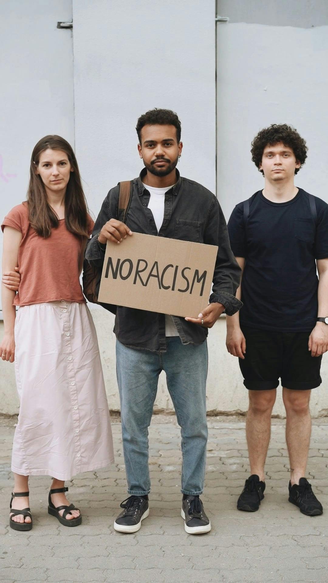 Man Holding A Placard On No Racism · Free Stock Video