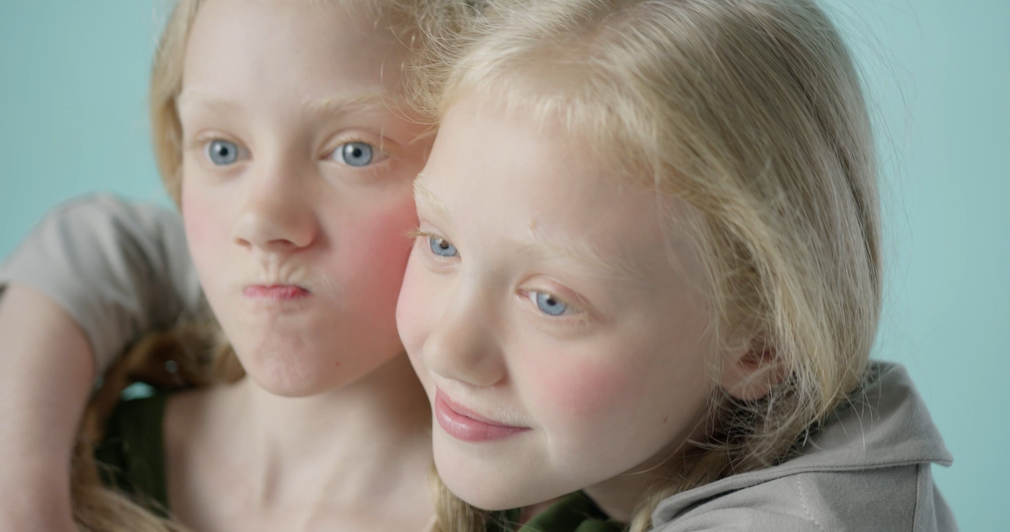 Two young girls with blue eyes are posing for a photo Free Stock Video ...