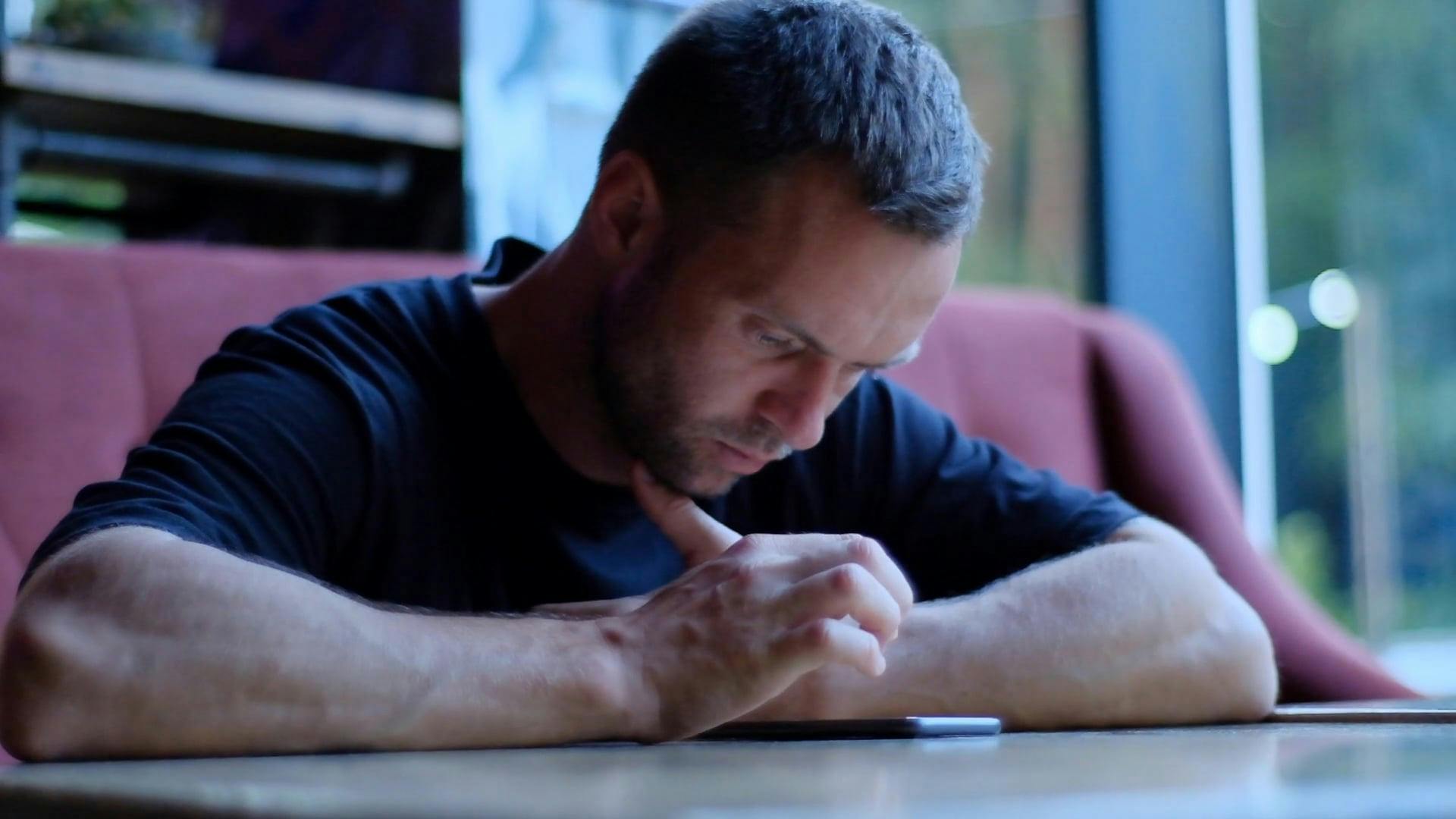 Man in Black Shirt Looking at His Smartphone · Free Stock Video