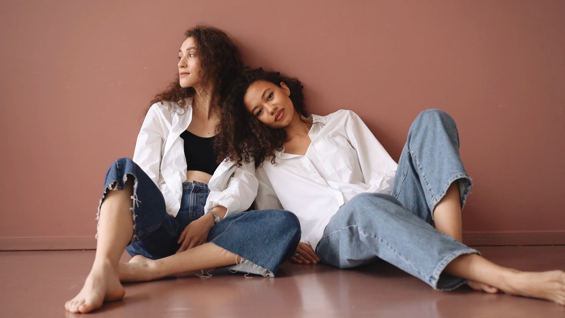 Women Modeling While Sitting on the Floor Facing Each Other · Free ...