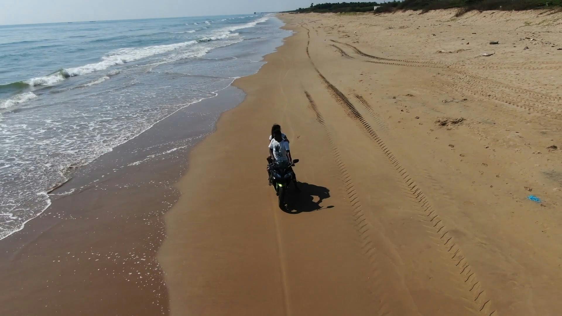 Couple Ridding a Motorcycle on the Beach · Free Stock Video