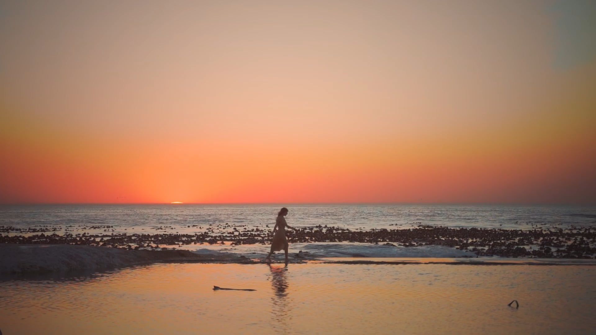 A Woman Walking at the Beach During Sunset · Free Stock Video