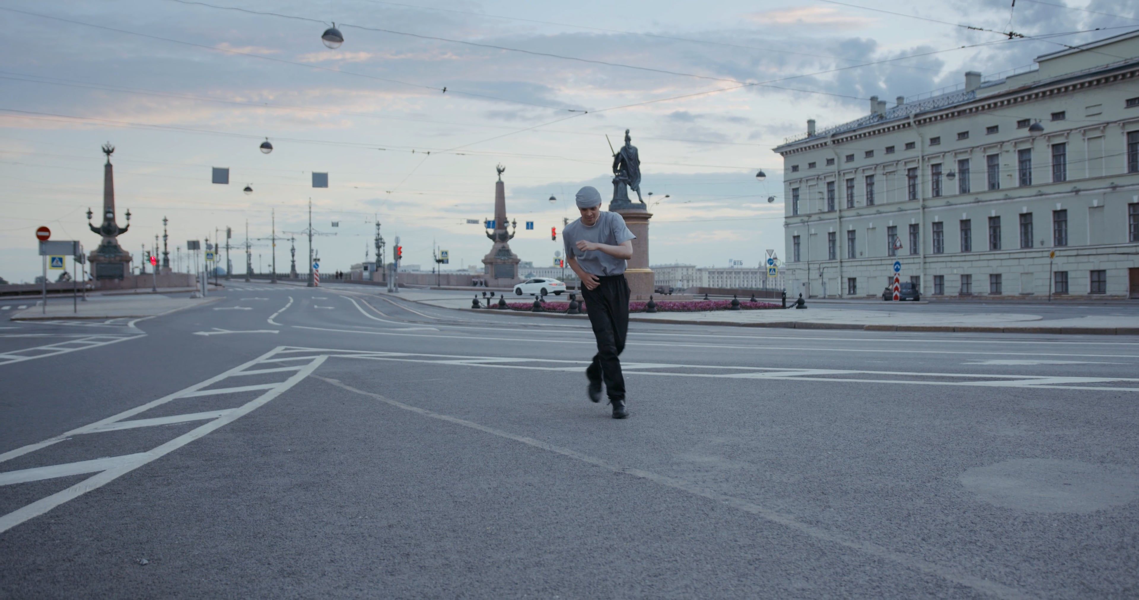 A man running down the street in front of a building Free Stock Video ...