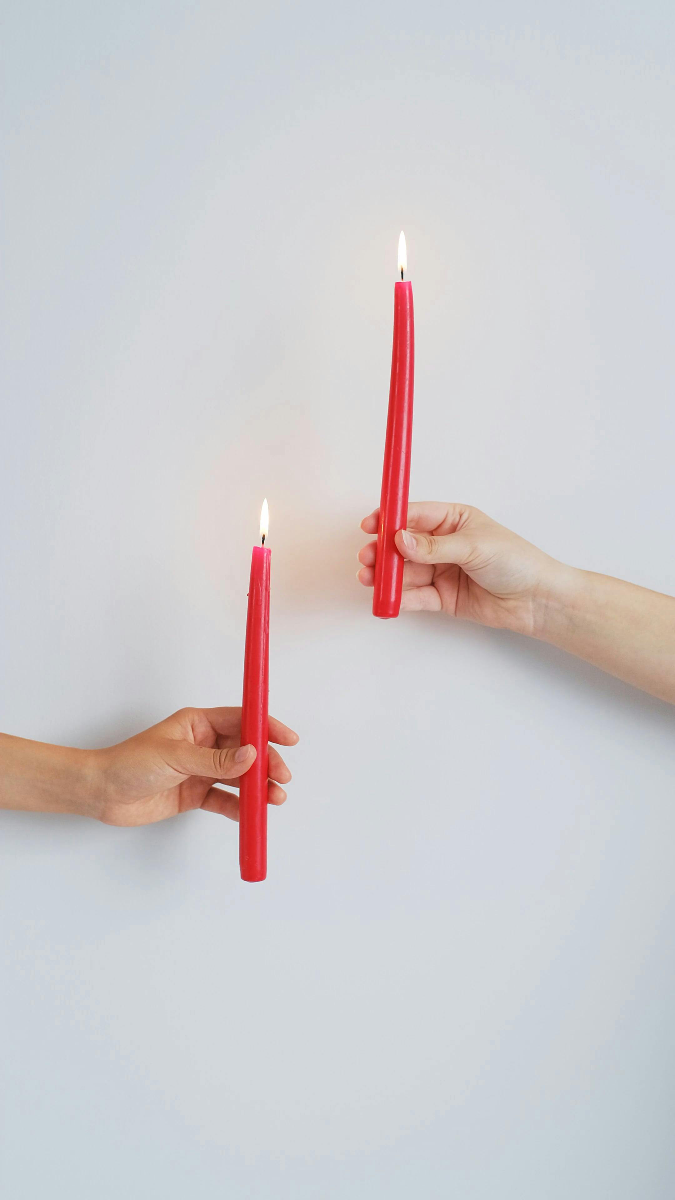 Hands Holding Red Candles · Free Stock Video