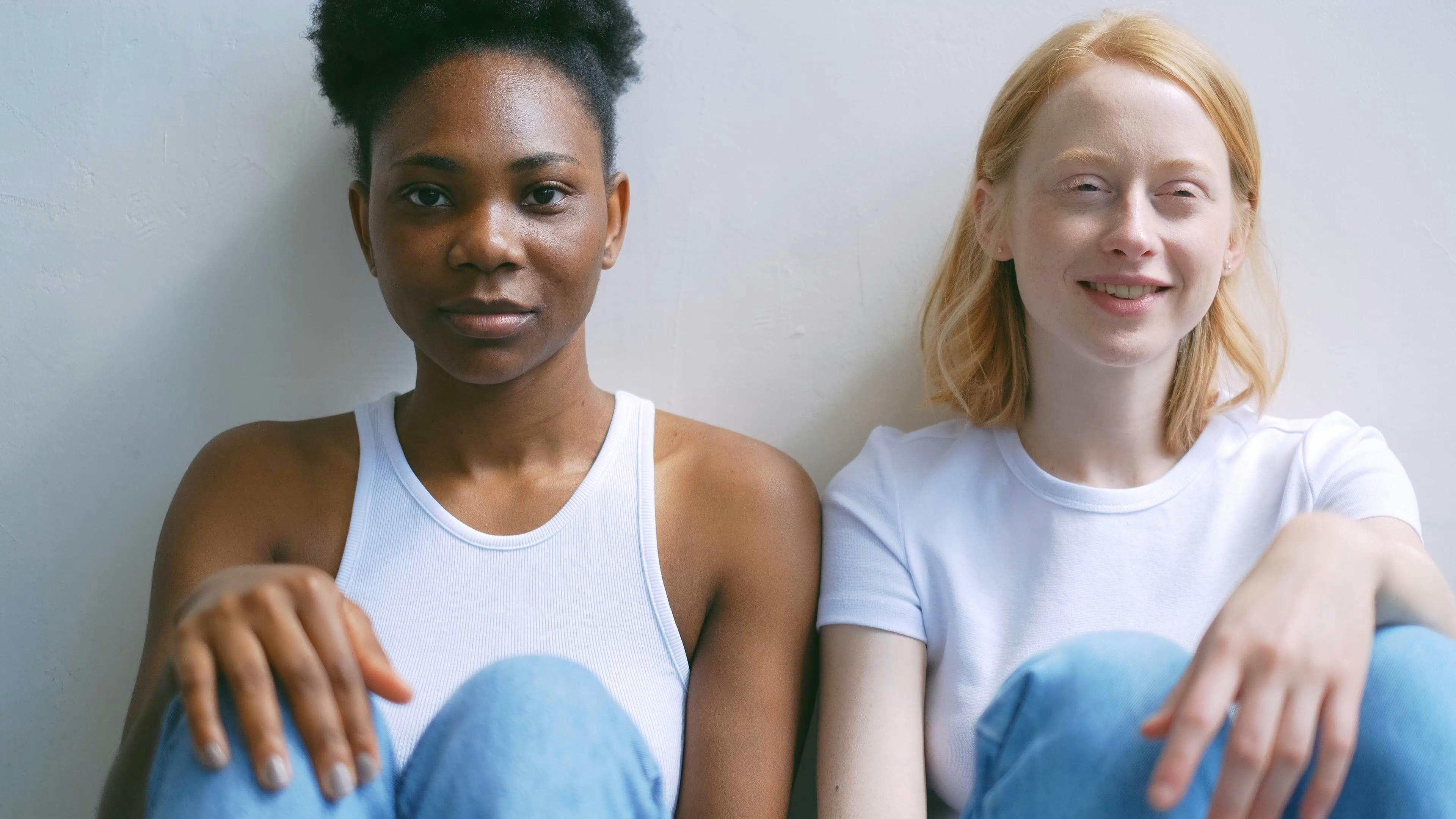 Two Women Sitting Side by Side and Smiling · Free Stock Video