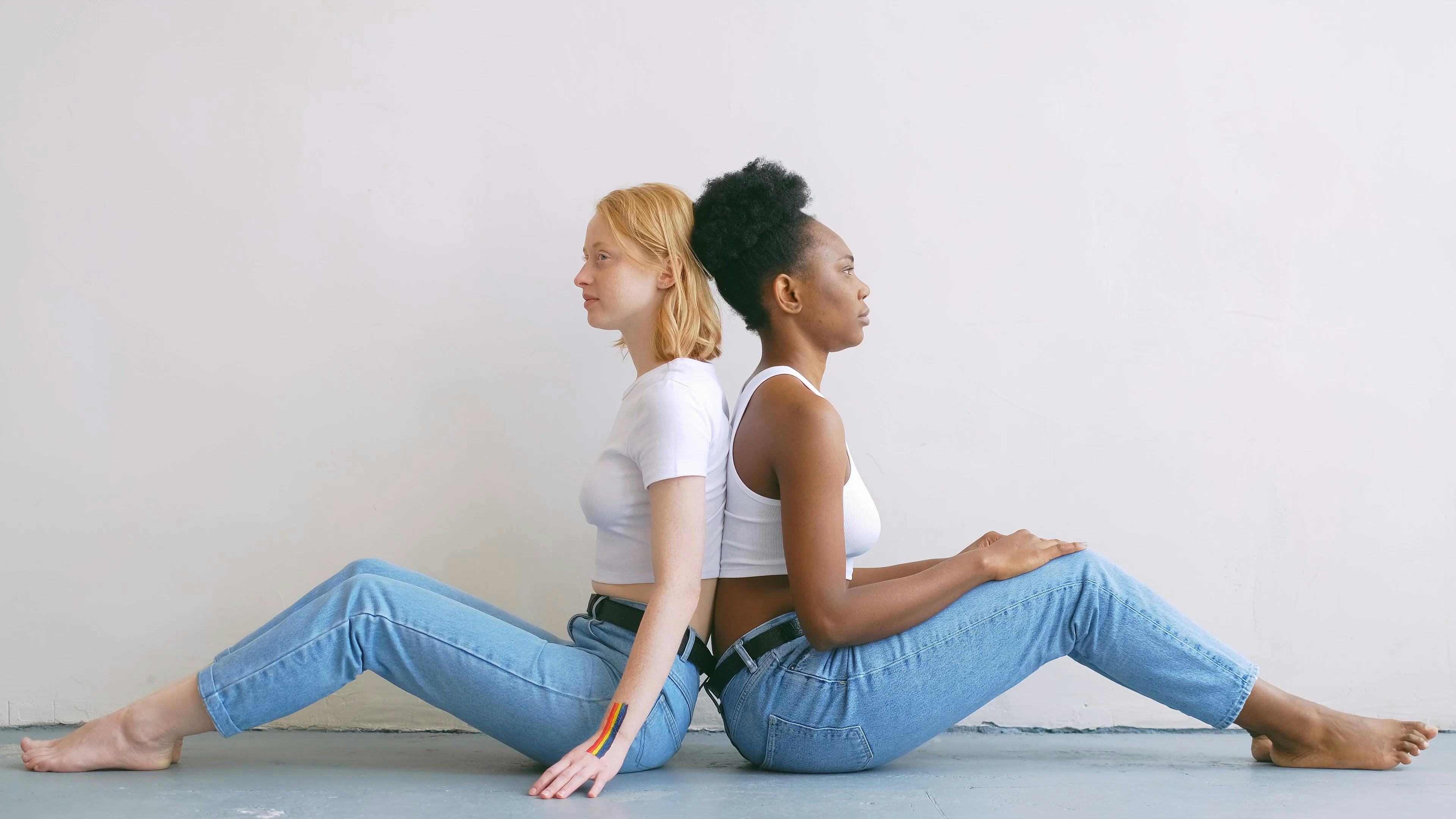 Two Women Sitting Back to Back · Free Stock Video